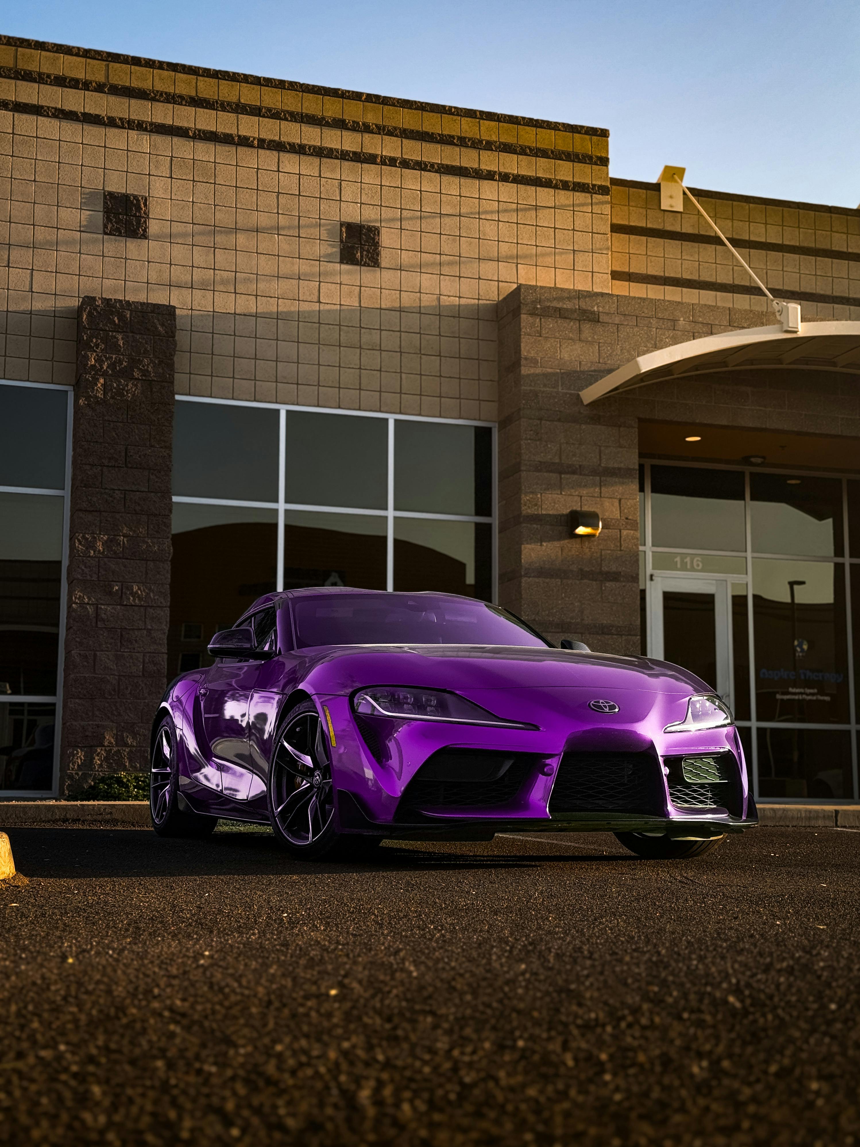 A Purple Toyota Supra Parked in Front of a Building · Free Stock Photo