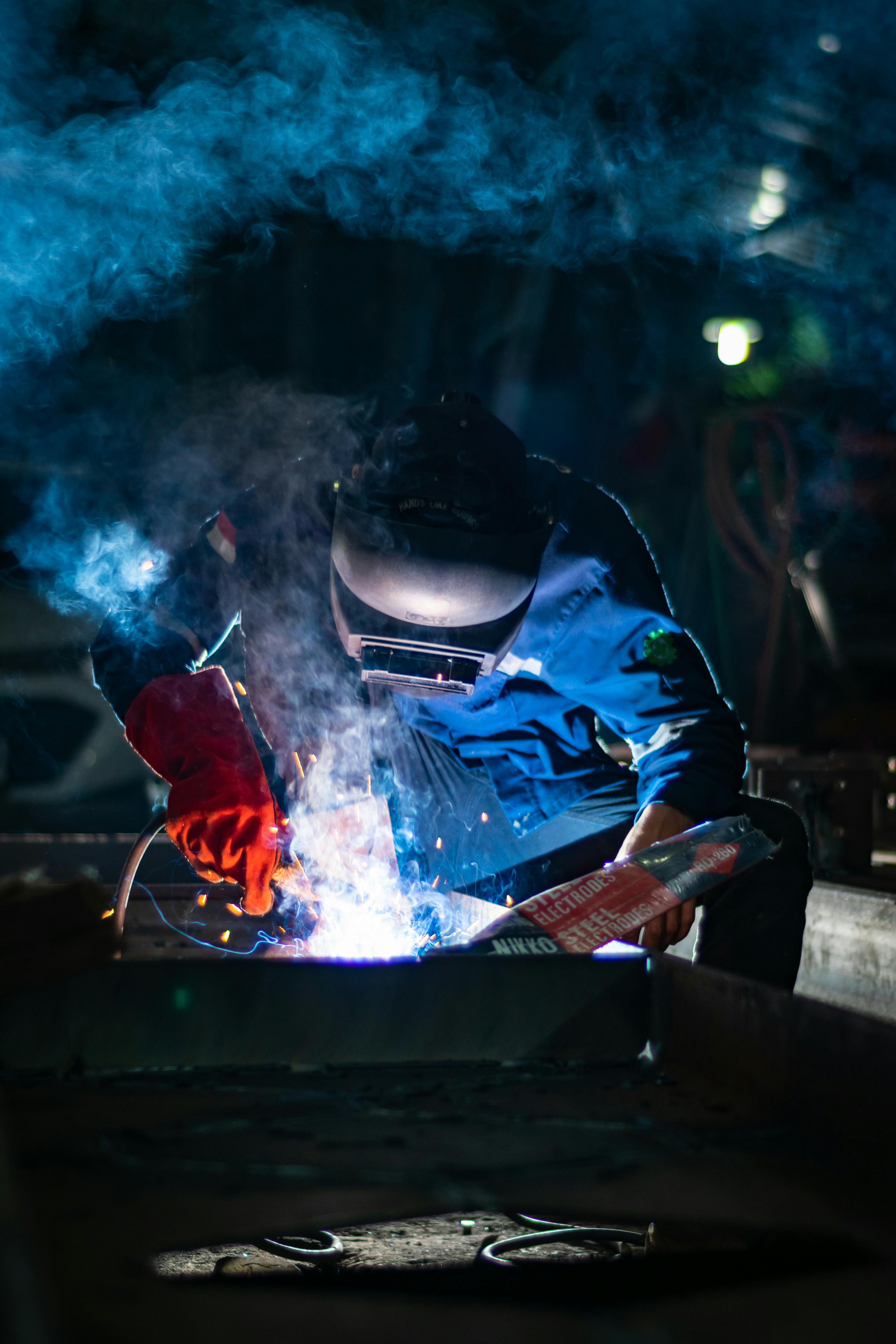 Welder Working in a Workshop · Free Stock Photo