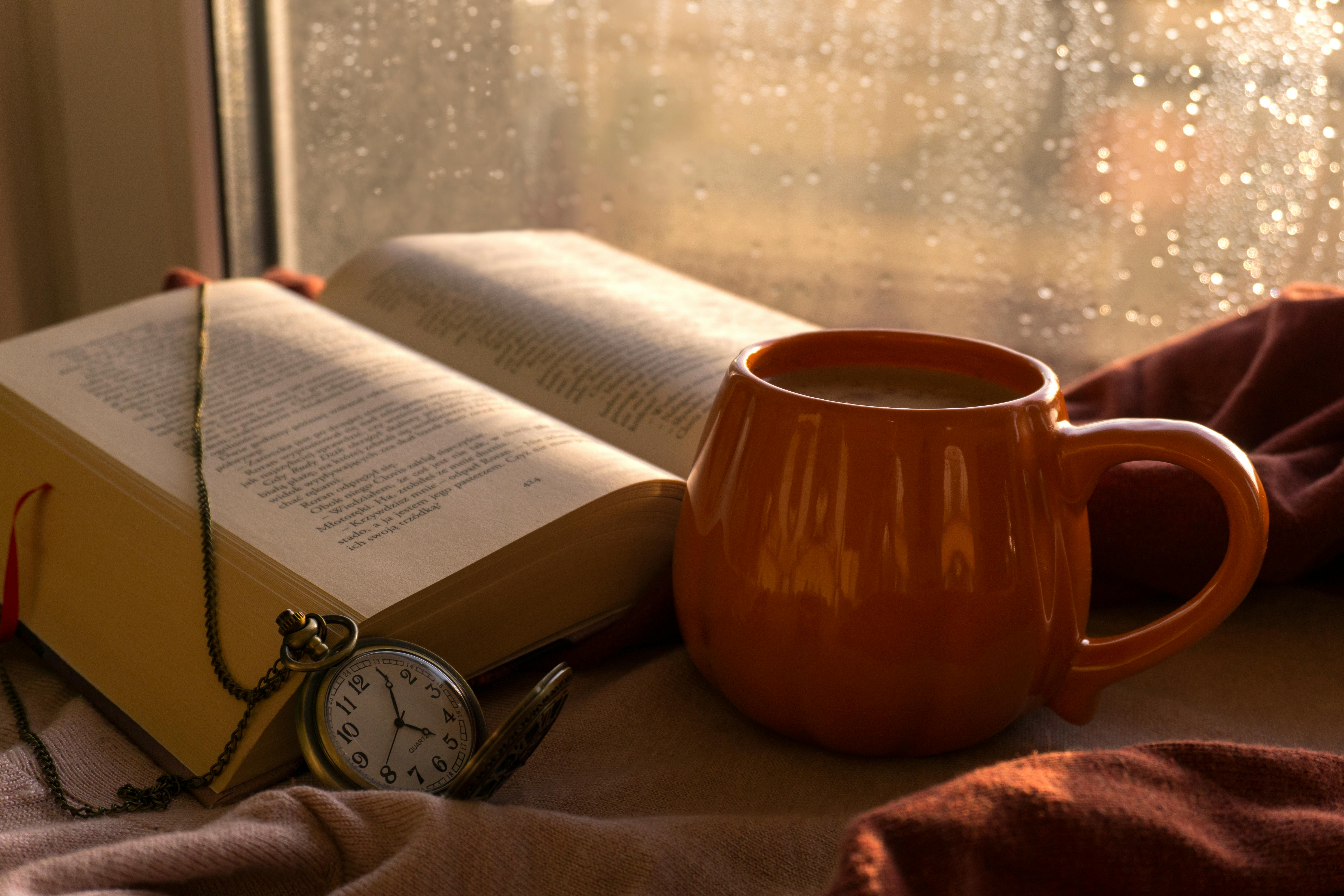 Mug and a Pocket Watch Lying by an Open Book · Free Stock Photo
