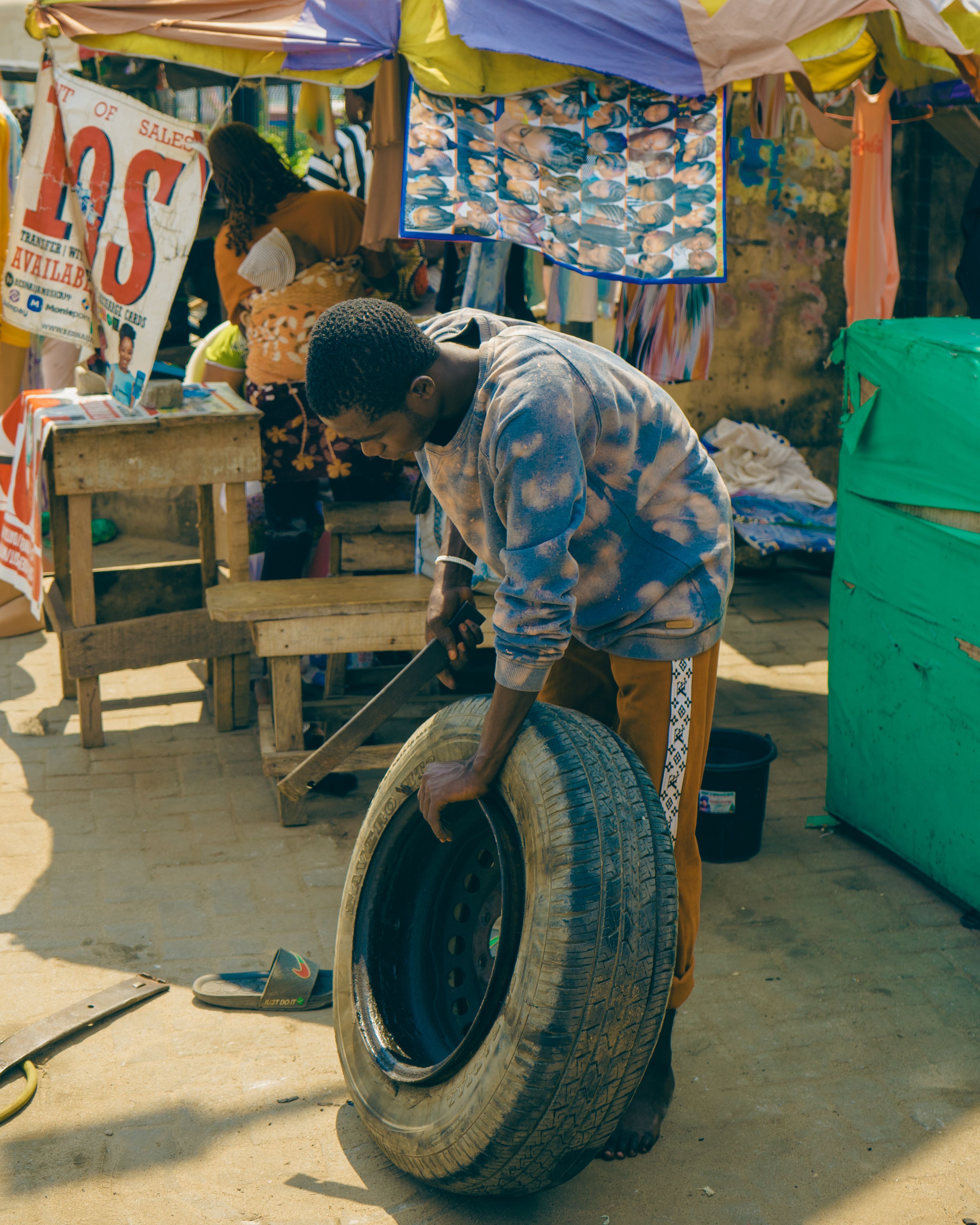 Man with Tire on Street Market · Free Stock Photo