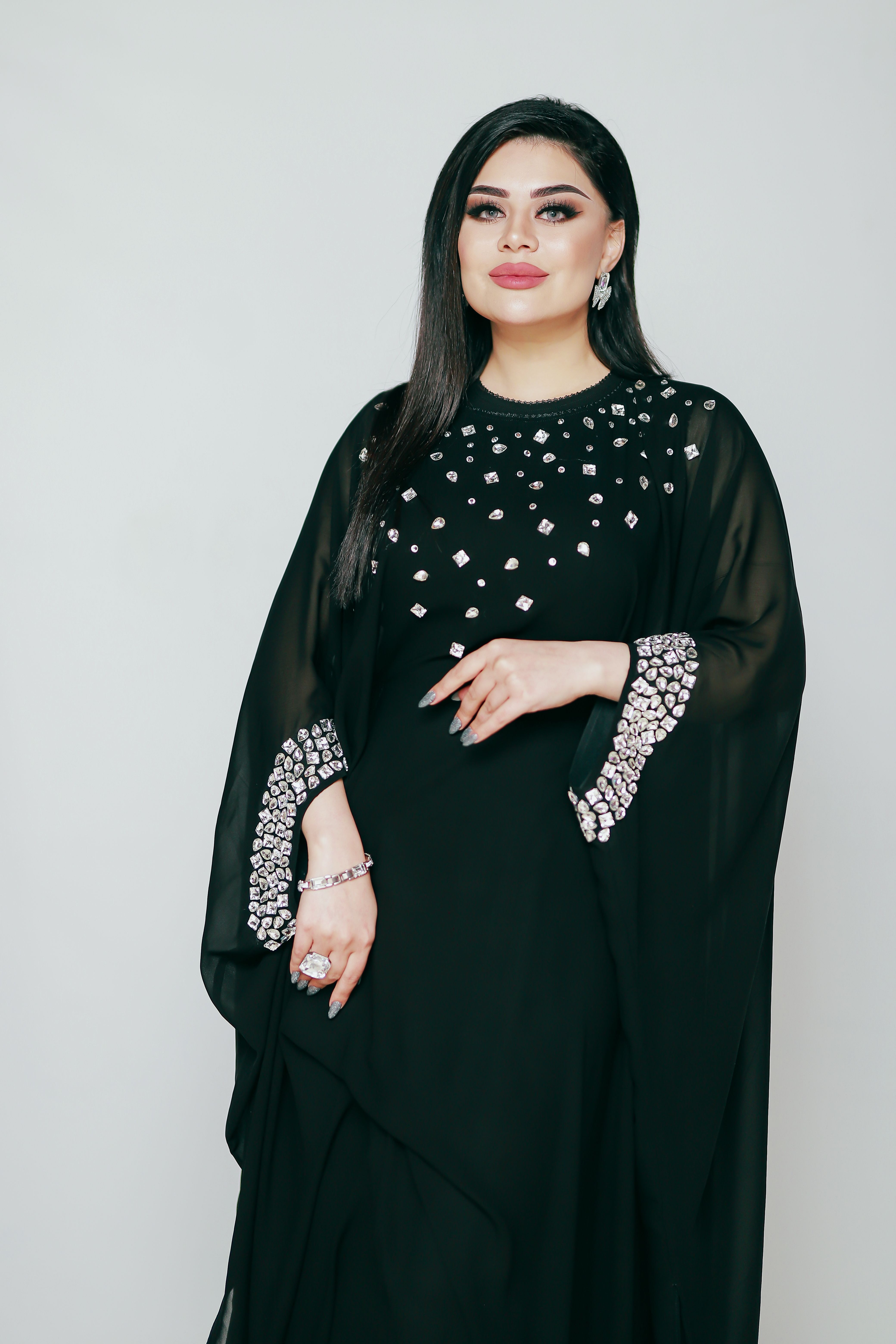 Young Woman Posing in an Ornate Abaya · Free Stock Photo