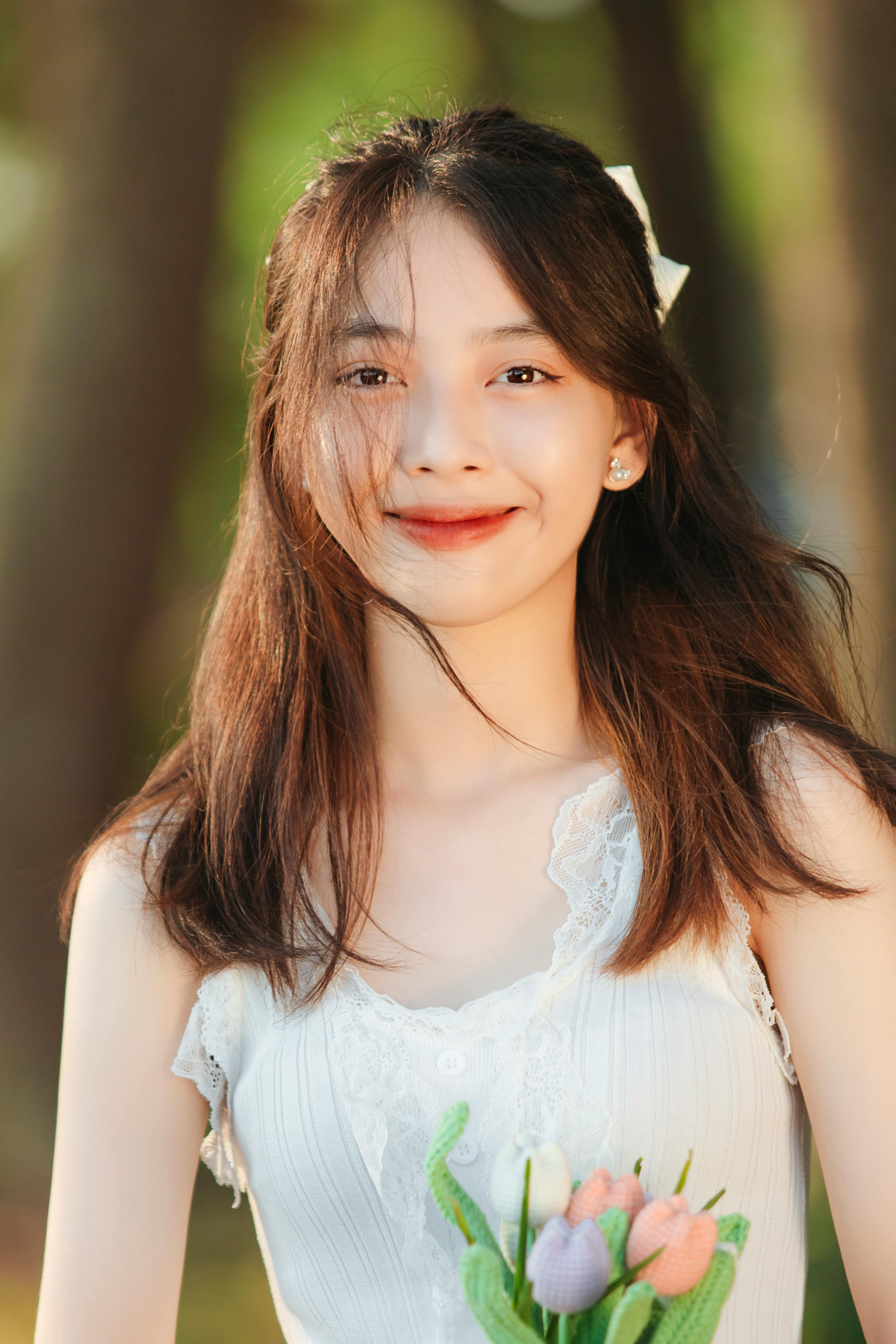 Sunlit Outdoor Portrait of Smiling Woman · Free Stock Photo