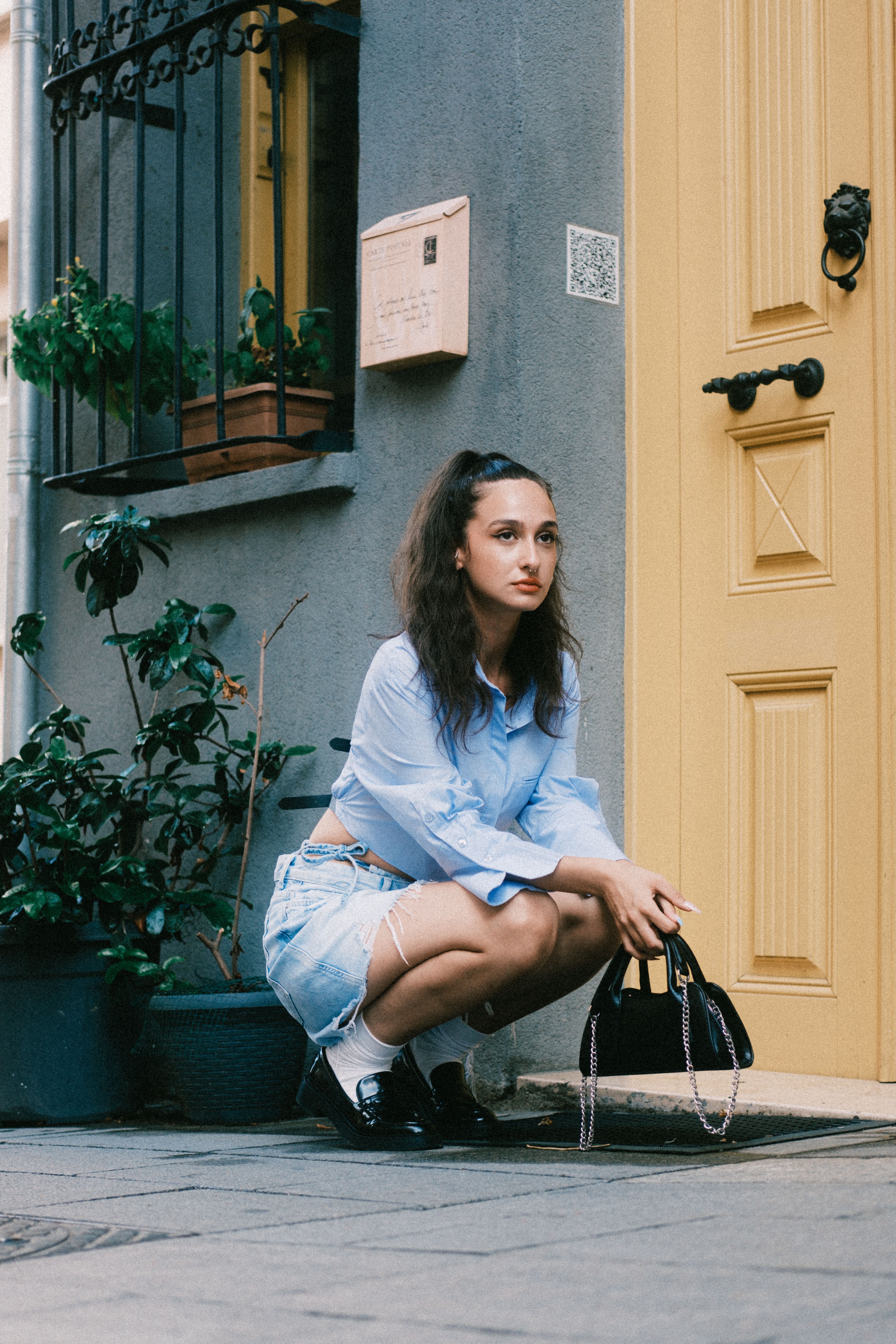 A Young, Fashionable Woman Posing by the Door · Free Stock Photo