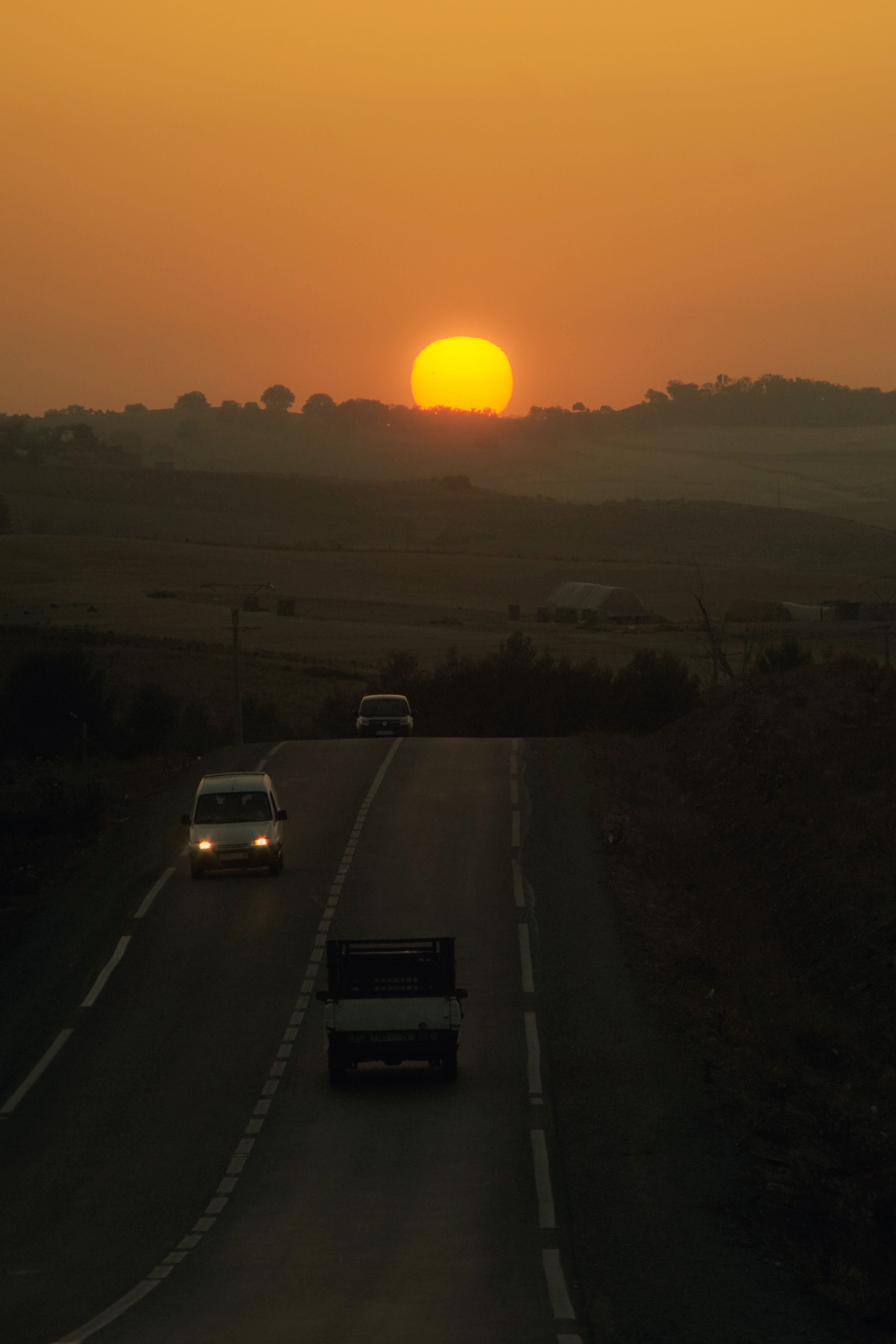 Cars on Road in Countryside at Sunset · Free Stock Photo