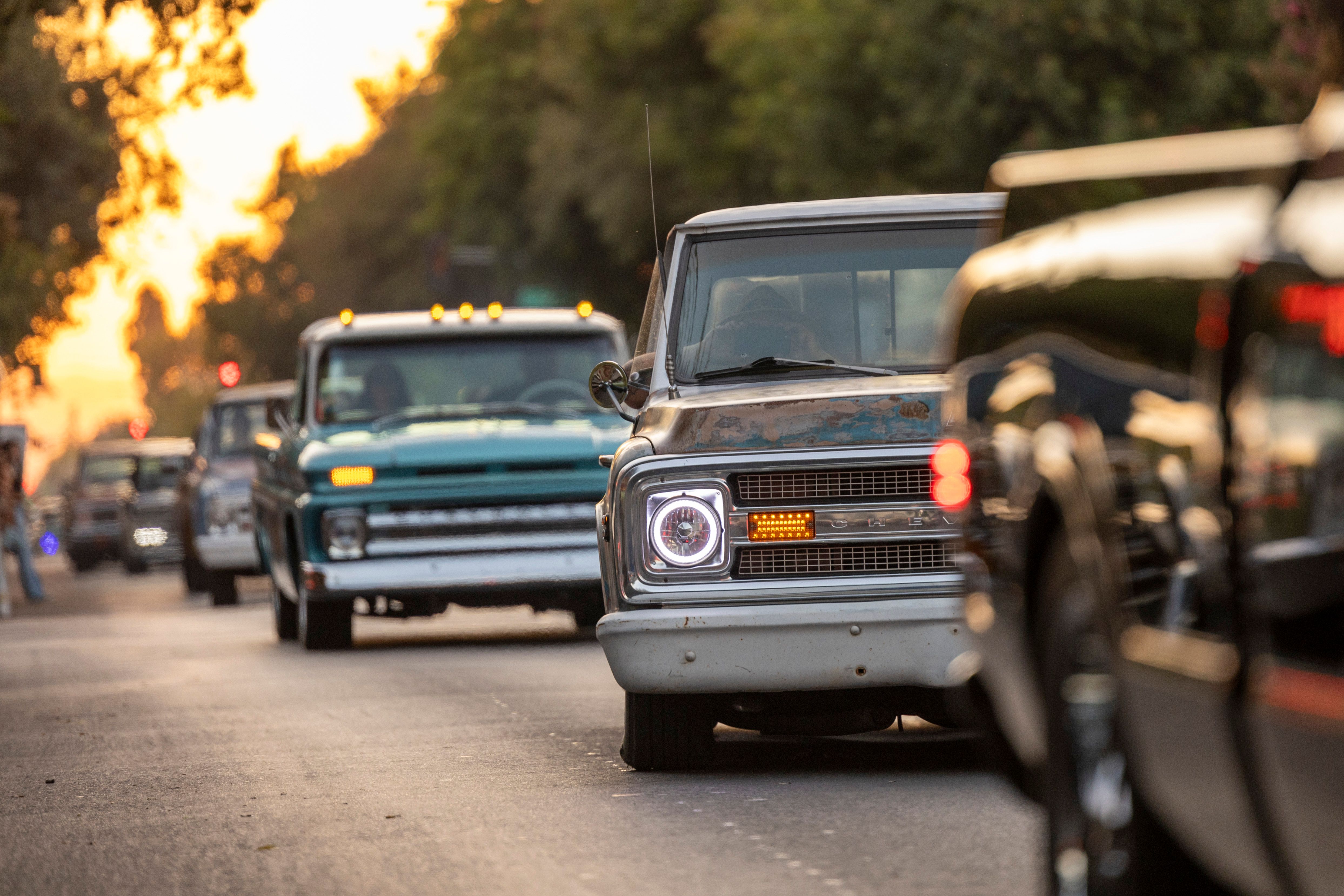 Vintage Cars Driving on the Road at Dusk · Free Stock Photo