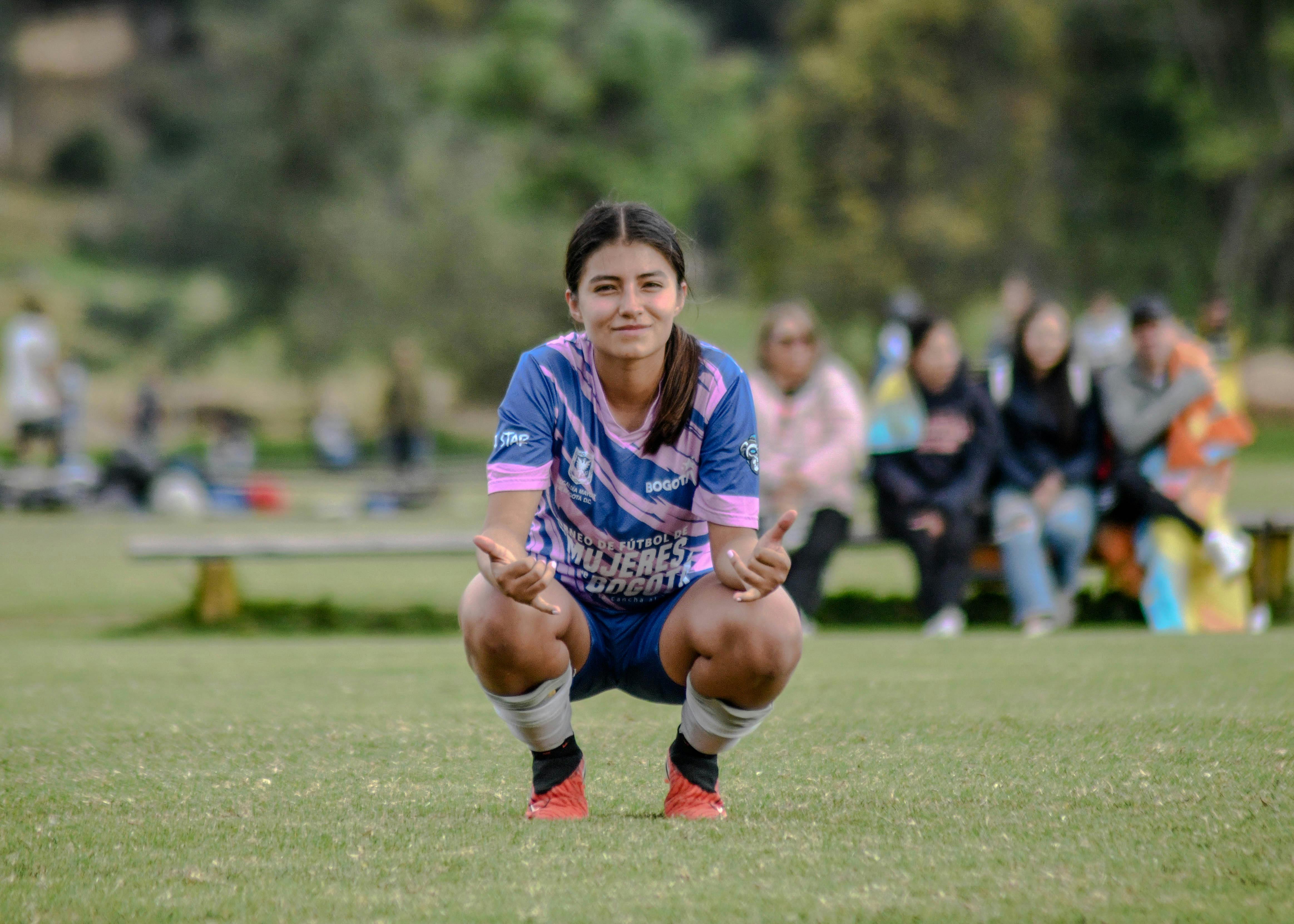 Female Soccer Player Posing on Field · Free Stock Photo