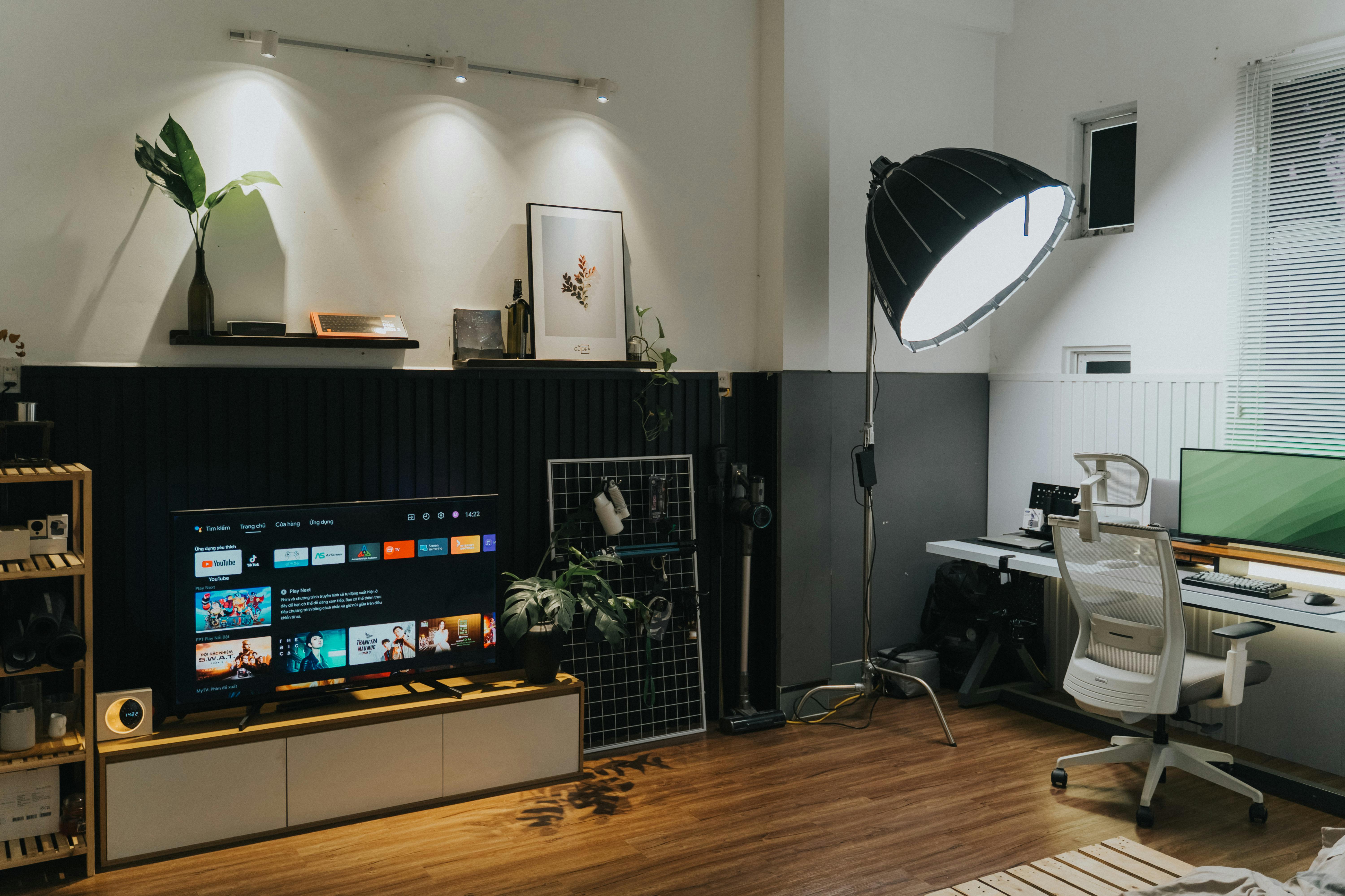 Desk with a Computer Lit by a Studio Lamp in the Living Room · Free ...