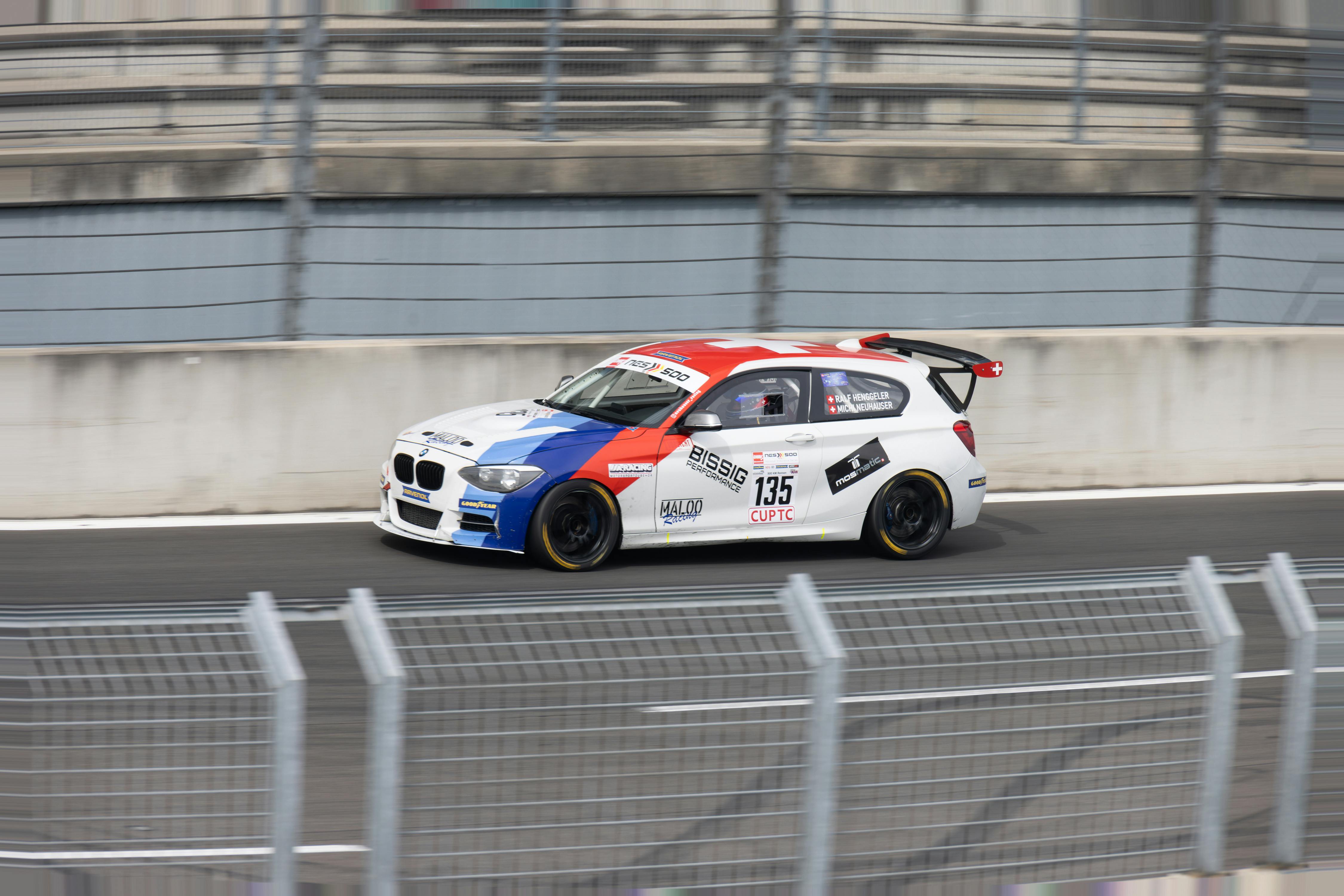 Red Racing Car on Race Track during Daytime · Free Stock Photo