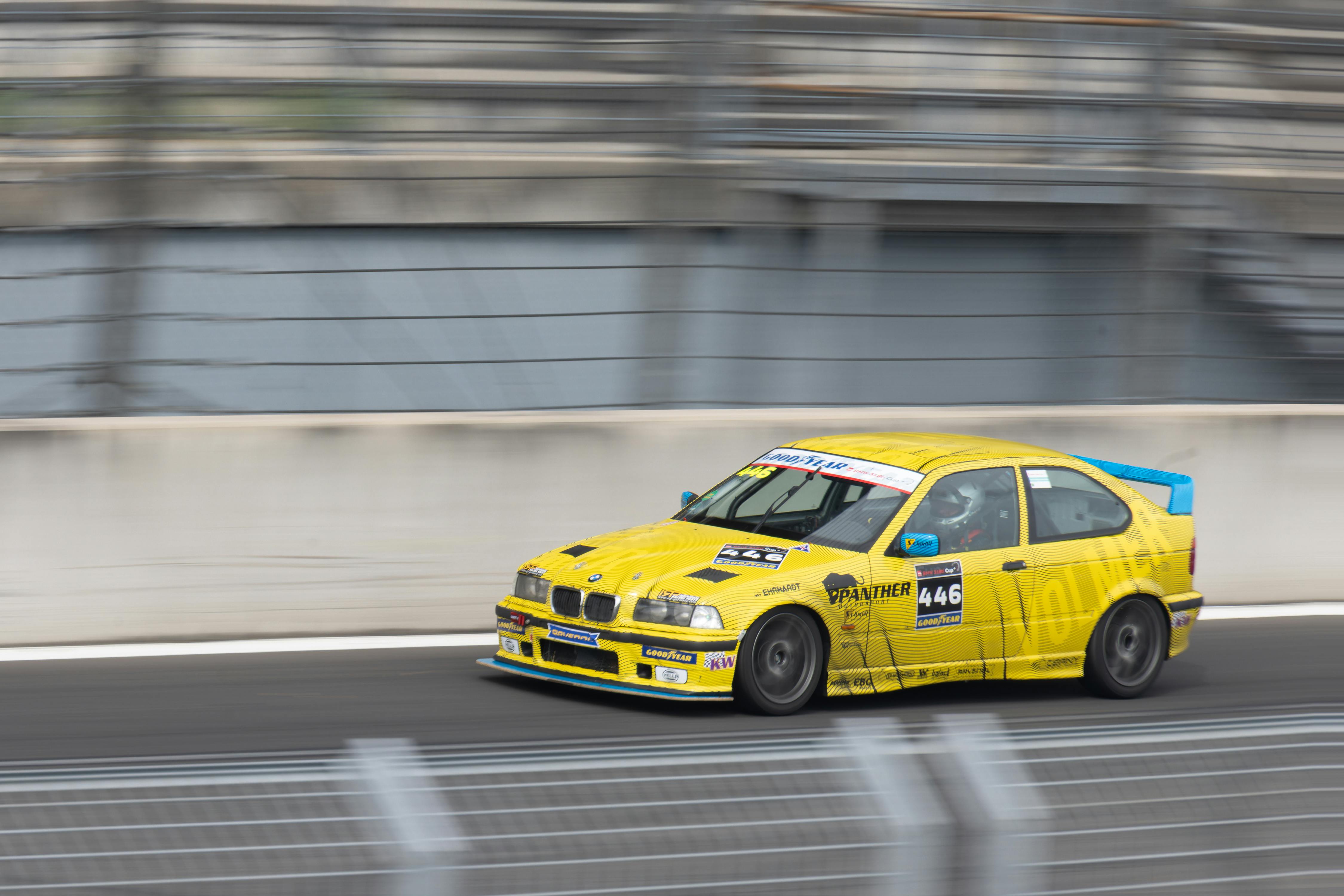 Red Racing Car on Race Track during Daytime · Free Stock Photo