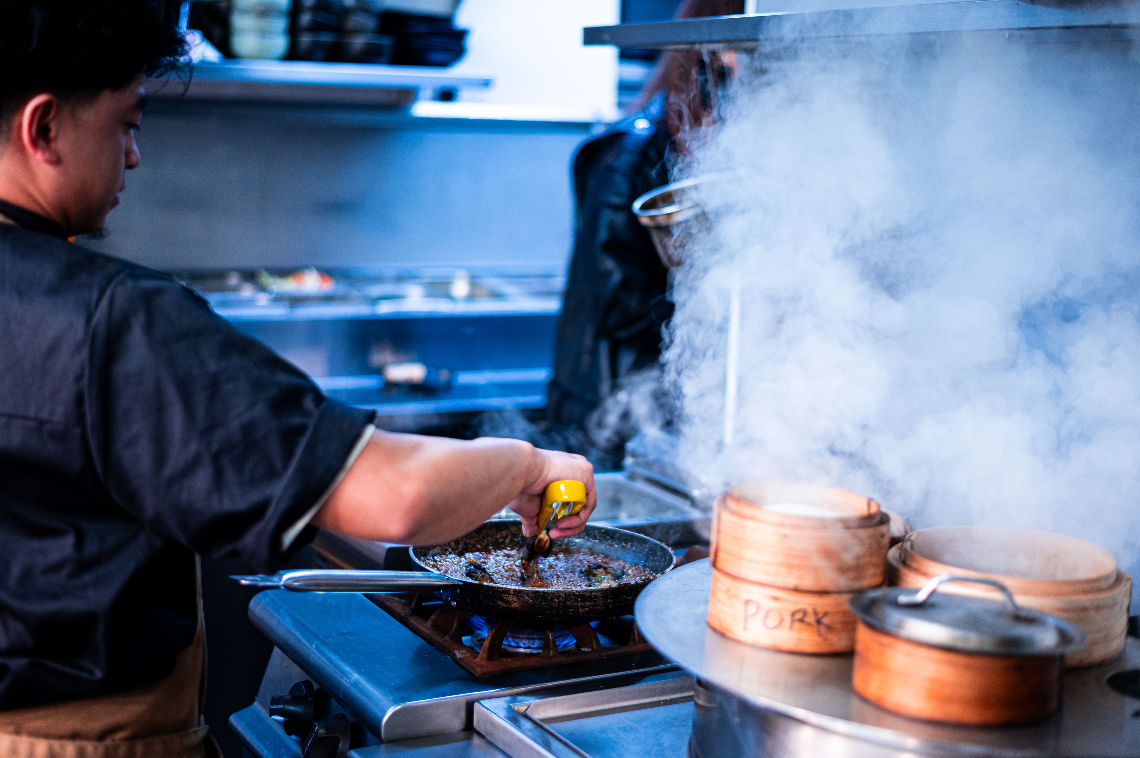 Cook Preparing Food in a Restaurant Kitchen · Free Stock Photo