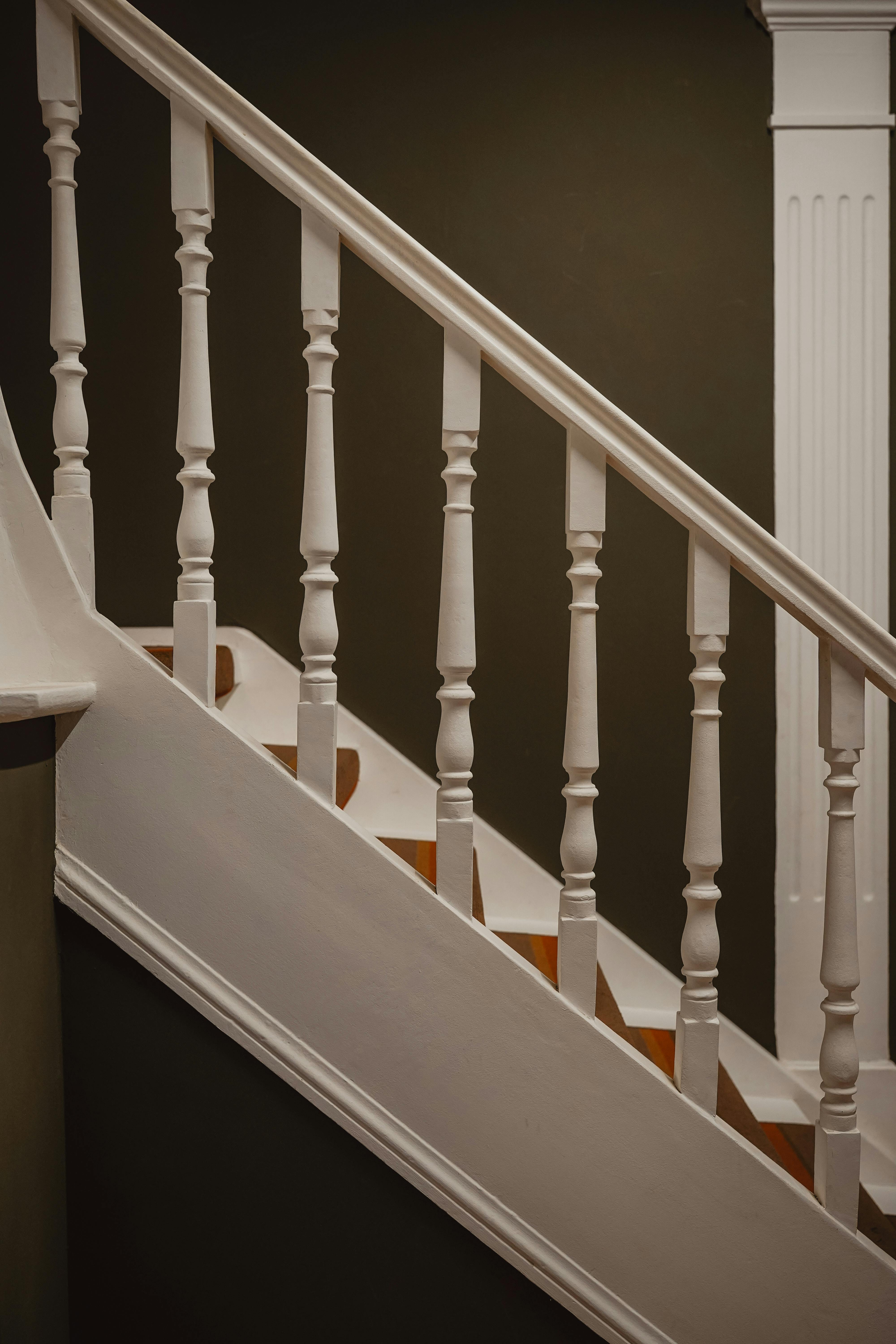 A staircase with white banisters and white railings · Free Stock Photo