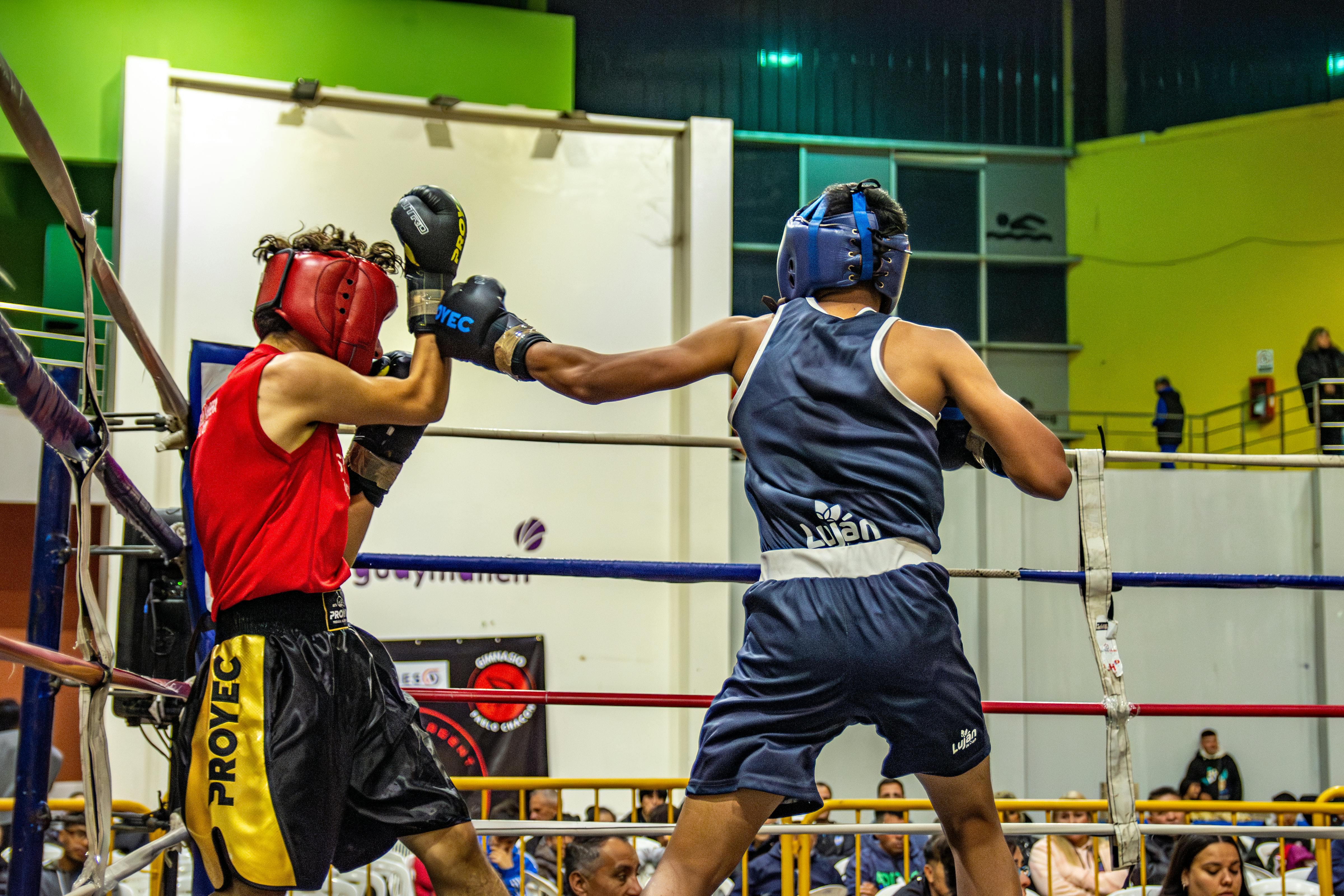 Low-Angle Photo of Two Men Fighting in Boxing Ring · Free Stock Photo