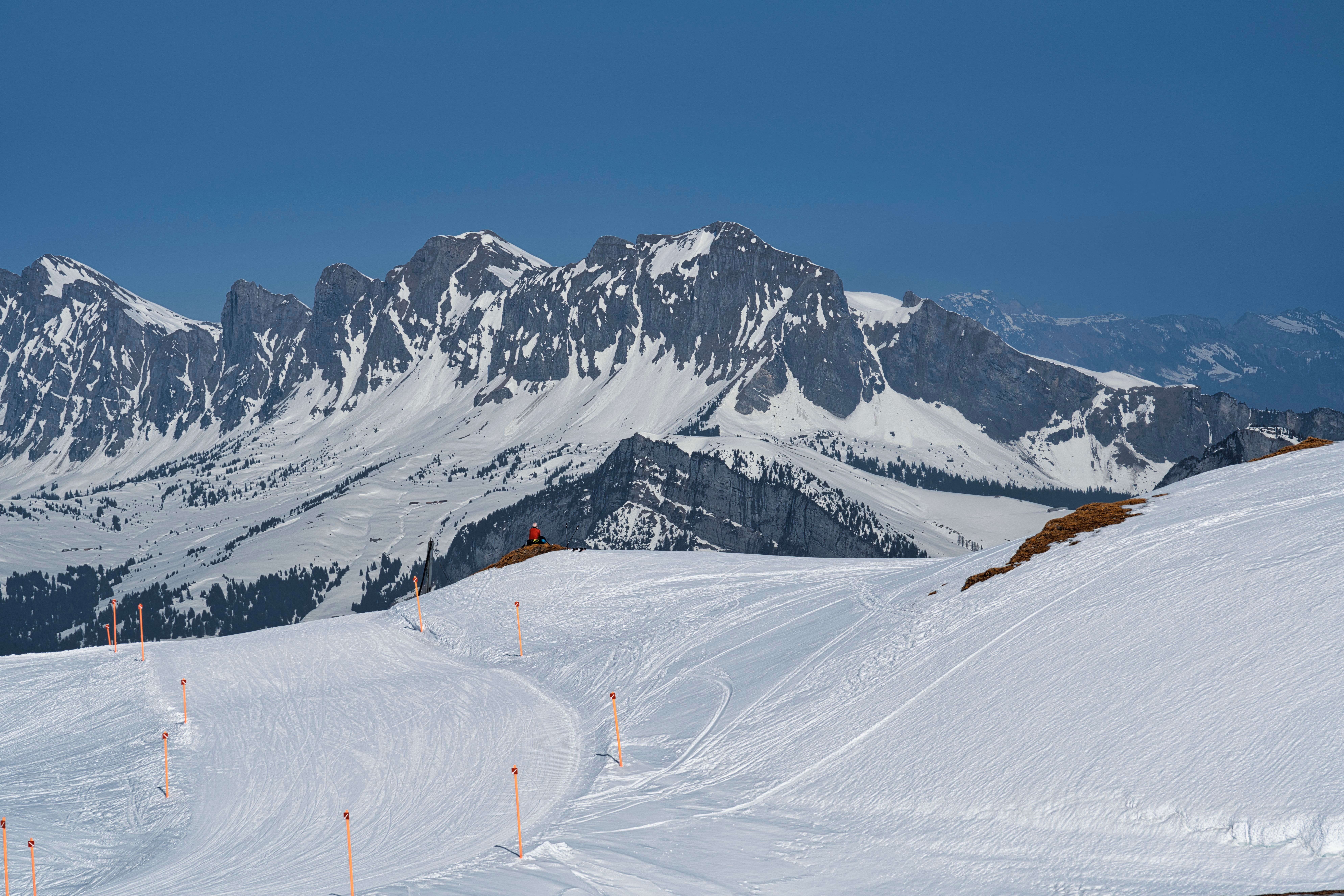 Skier on a Rock Admiring the Mountain Views · Free Stock Photo