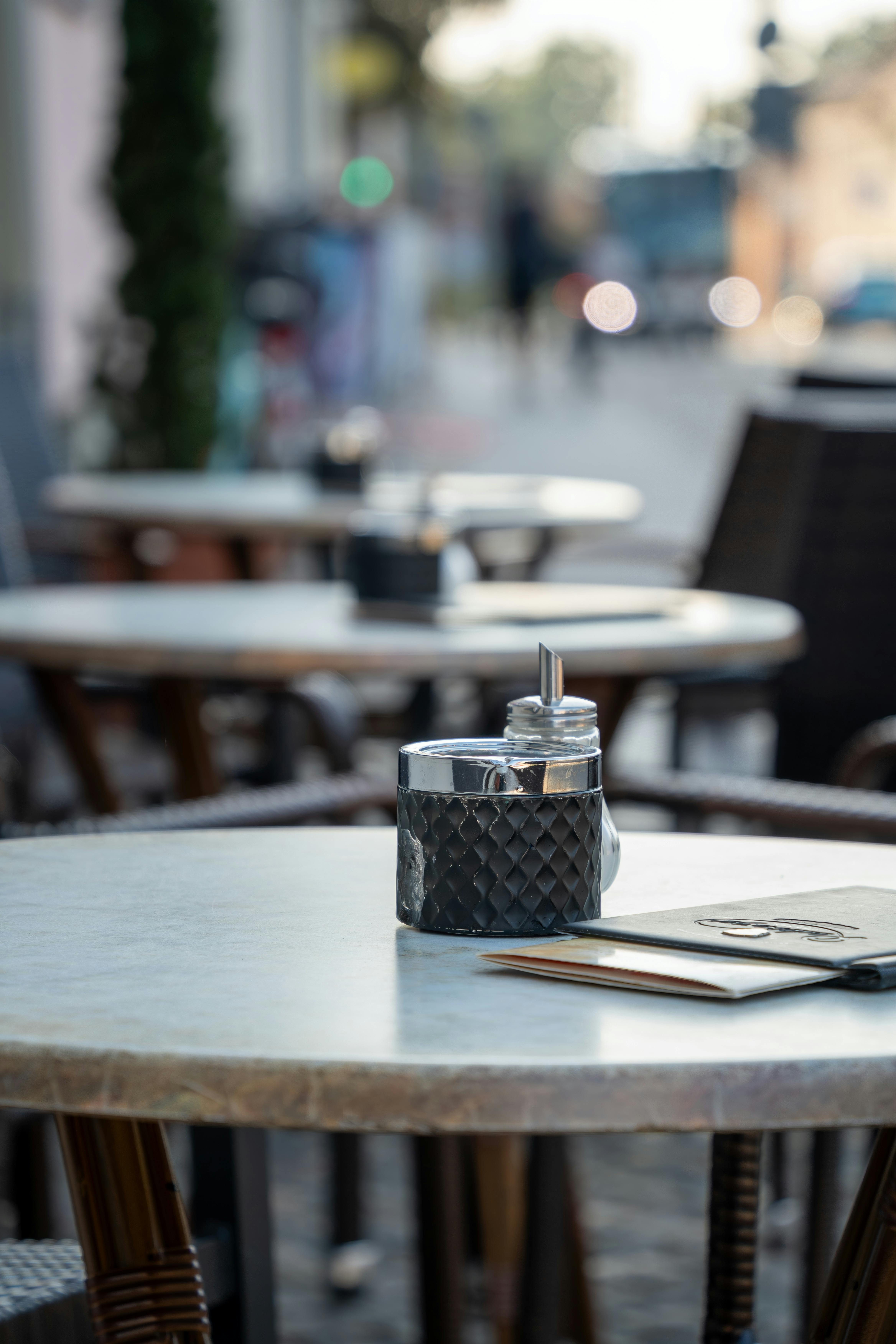 Street view of a coffee terrace with tables and chairs · Free Stock Photo