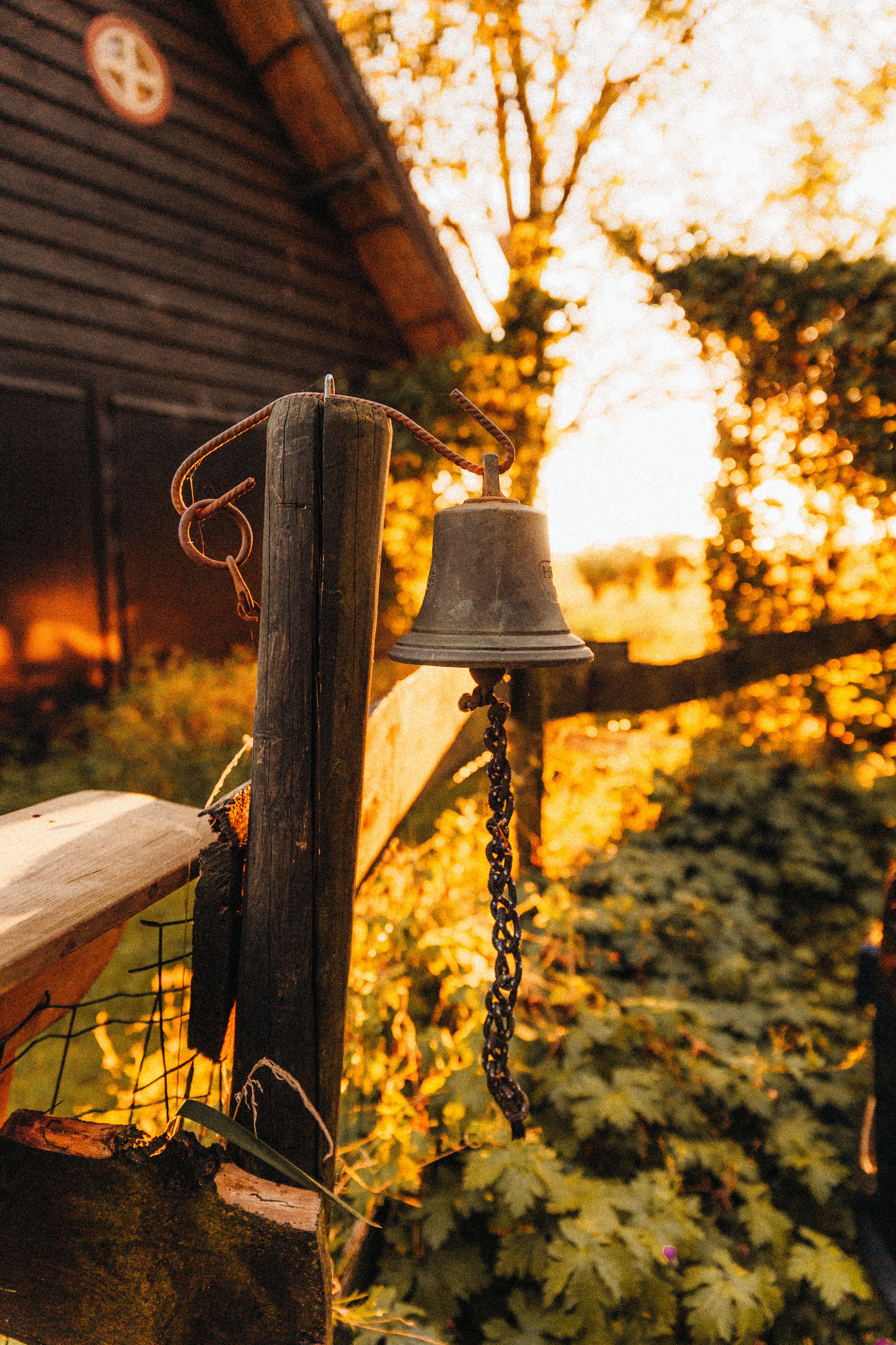 Bell on House Fence at Sunset · Free Stock Photo