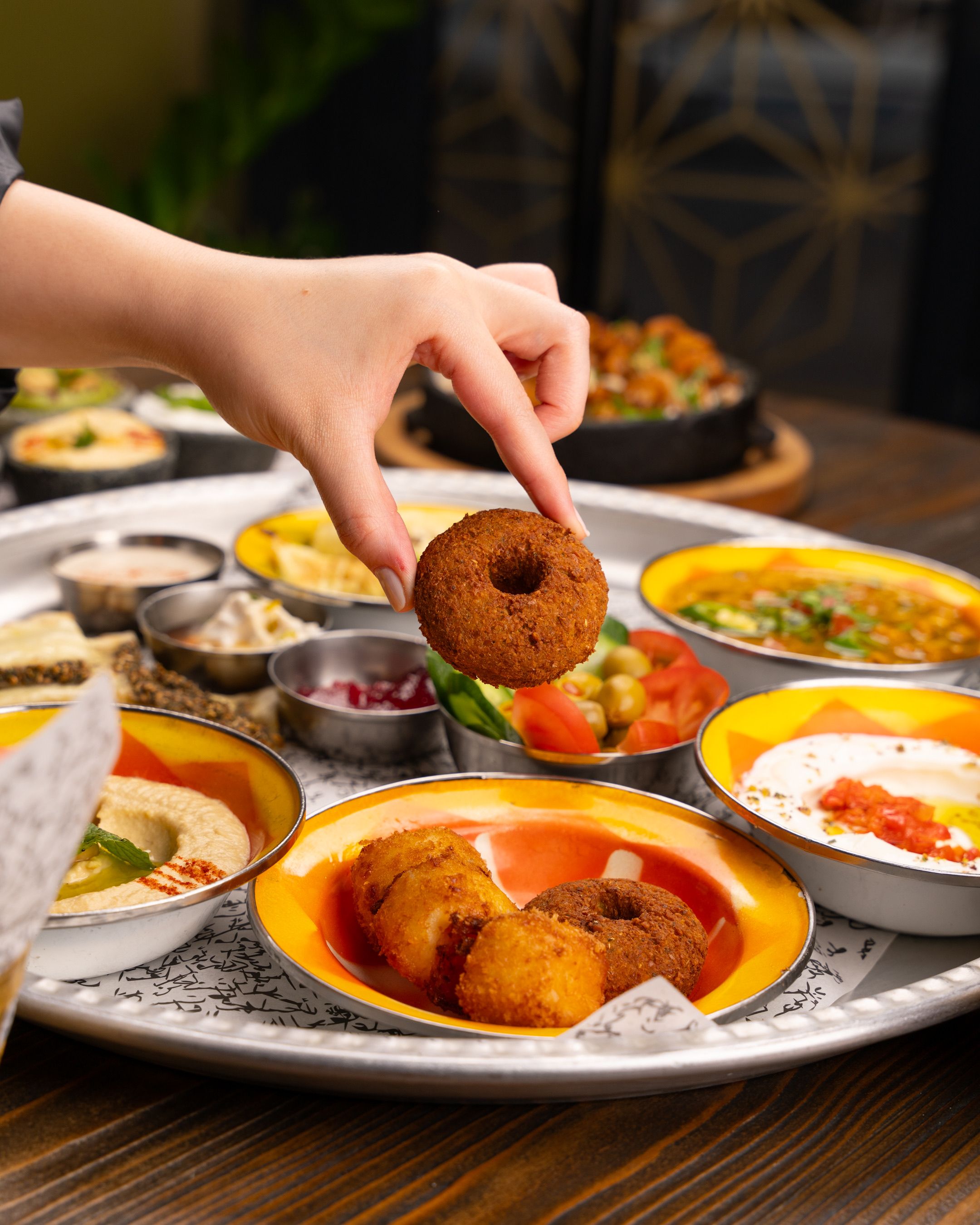 Woman Hand Holding Food over Plates · Free Stock Photo