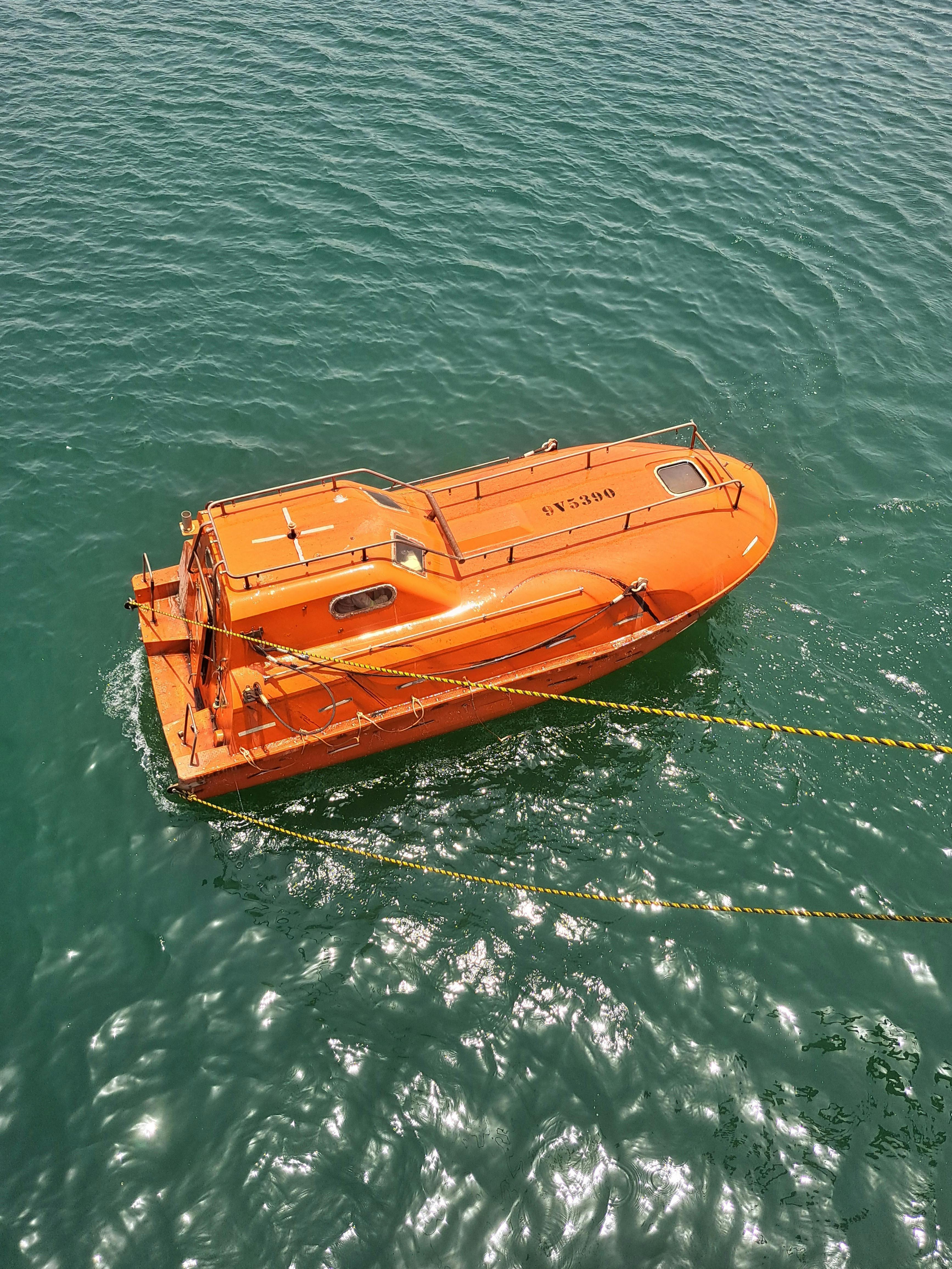 Orange Motorboat on Shore · Free Stock Photo