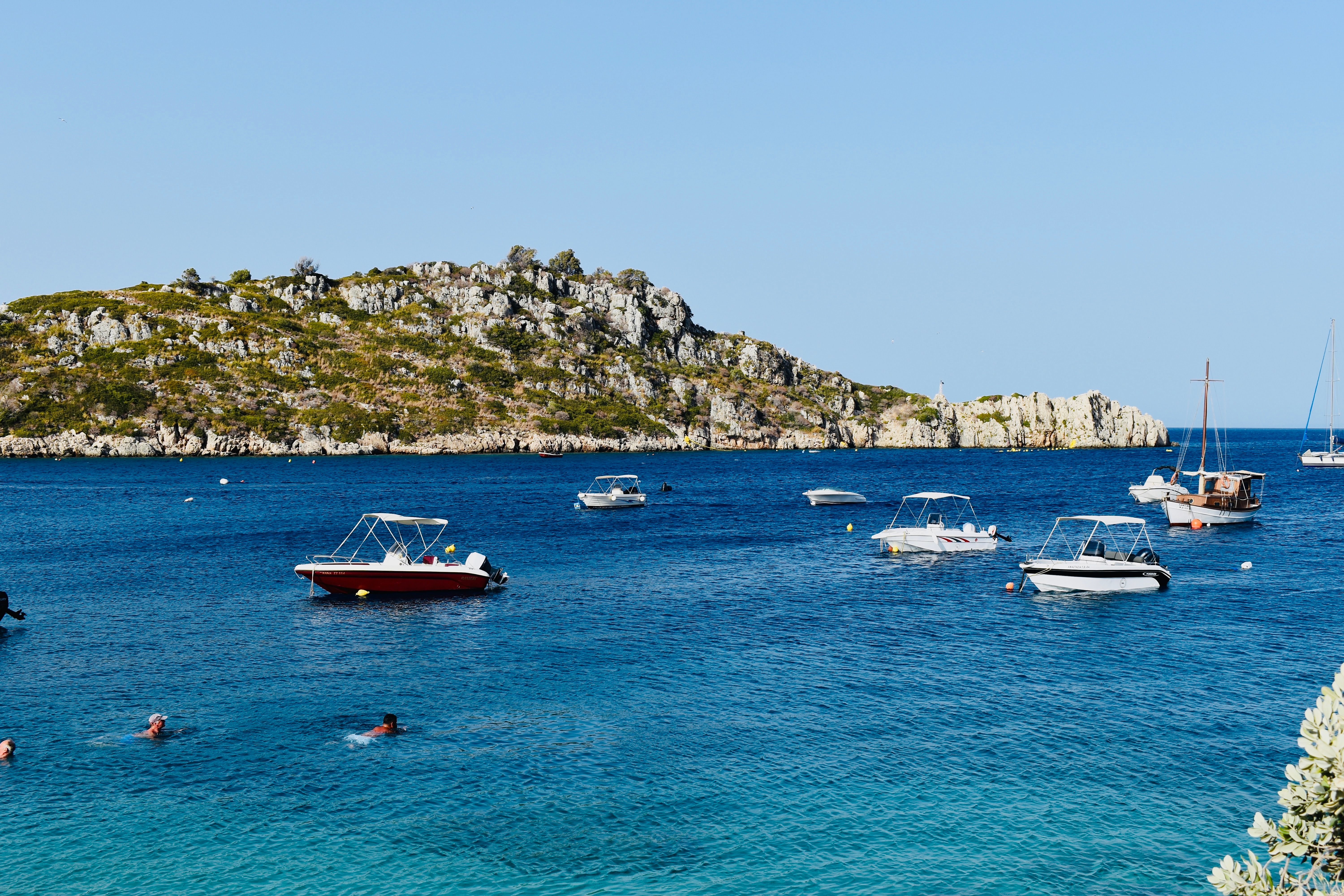 View of Boats Sailing near the Rocky Shore · Free Stock Photo