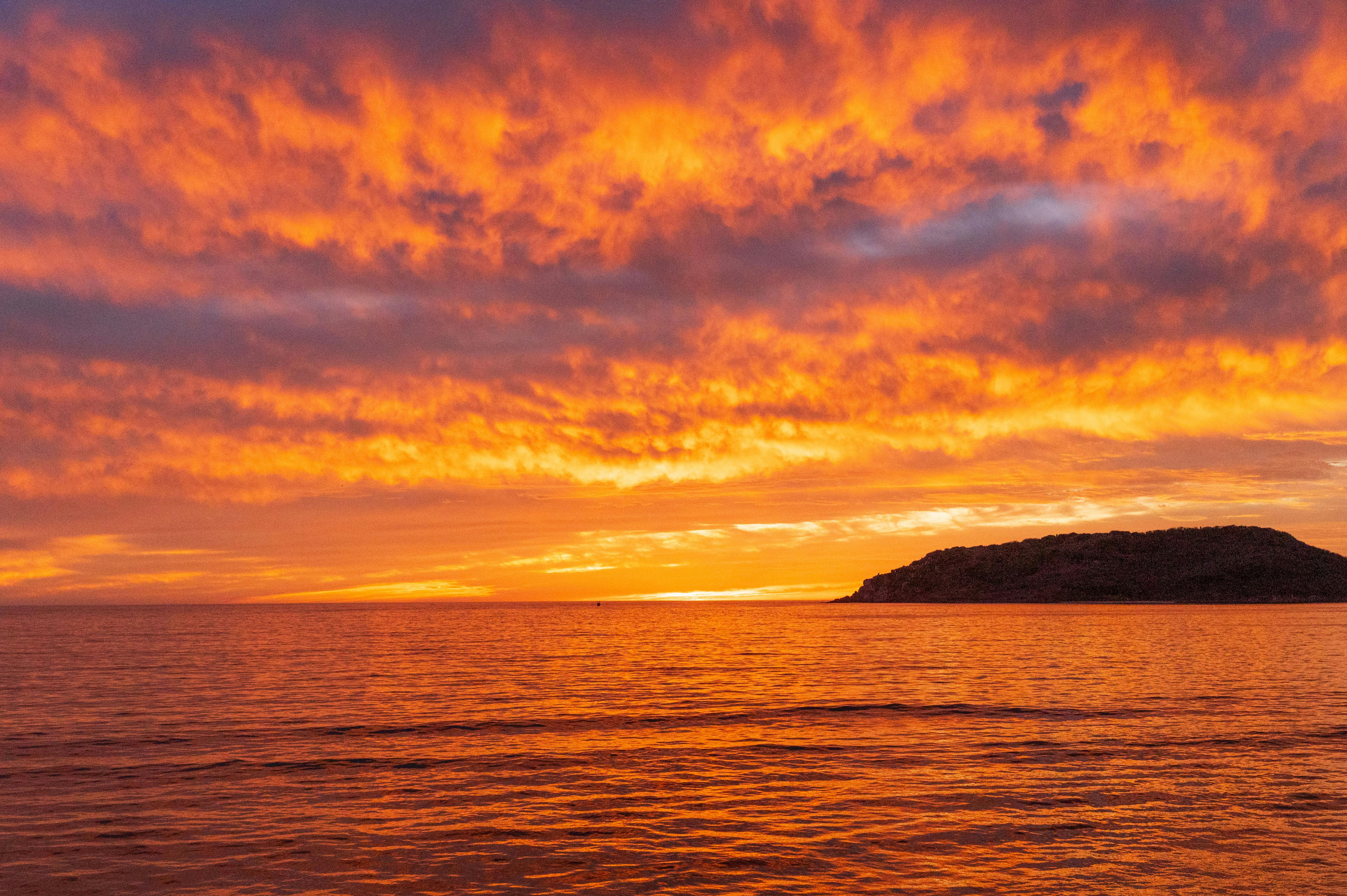 Blue Sea Under Yellow Sky · Free Stock Photo