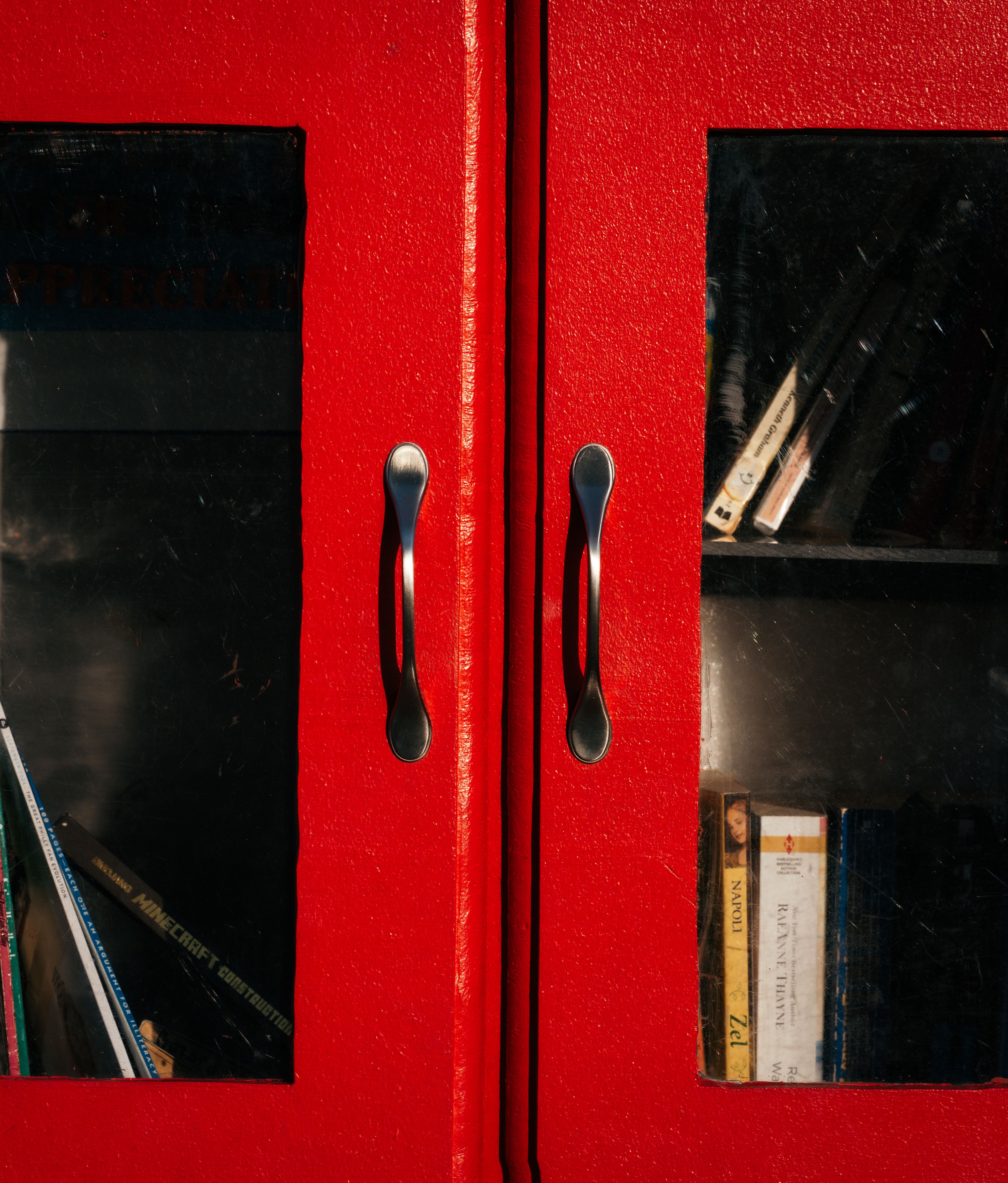 A red cabinet with books inside · Free Stock Photo