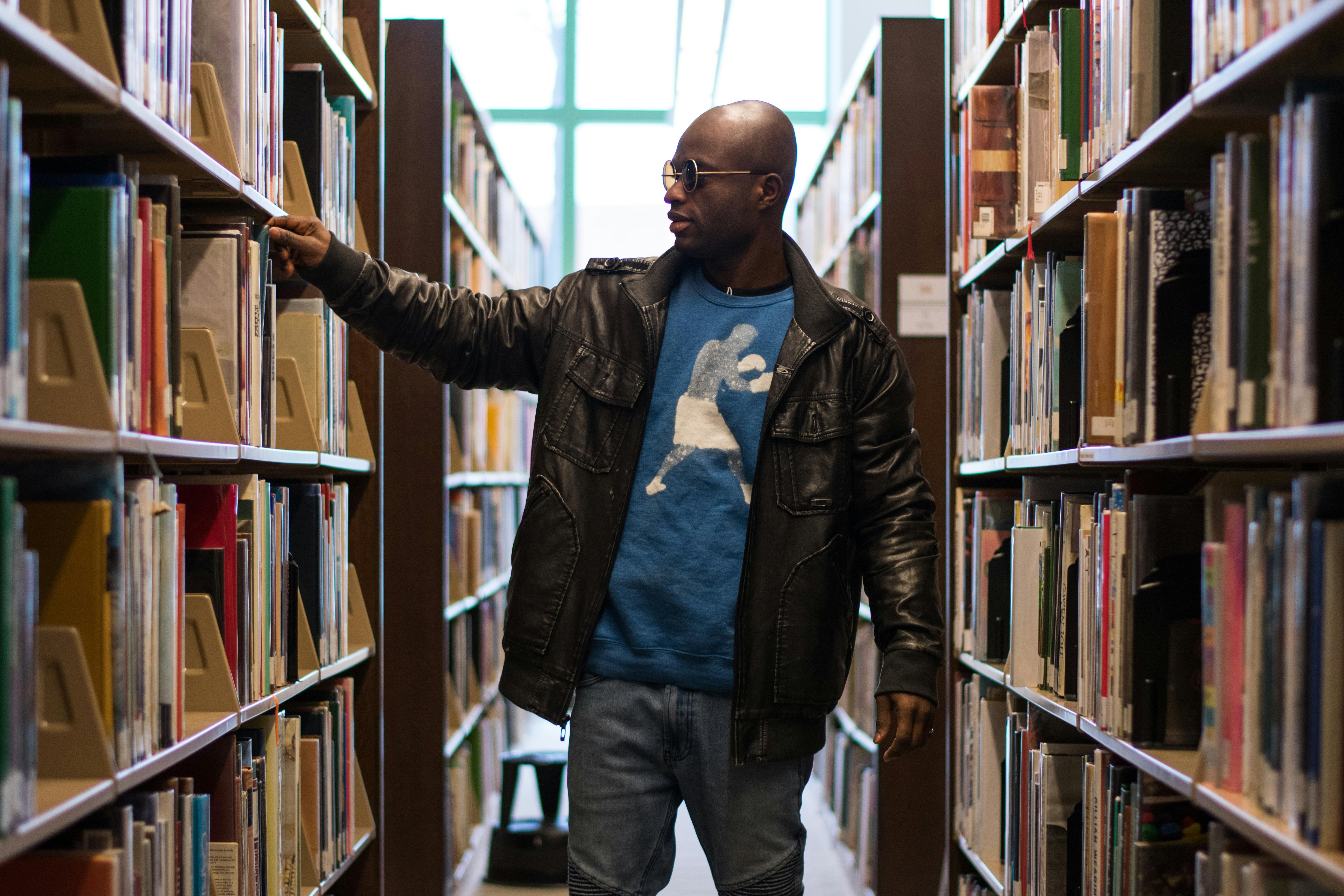 Man Searching Book in Library · Free Stock Photo