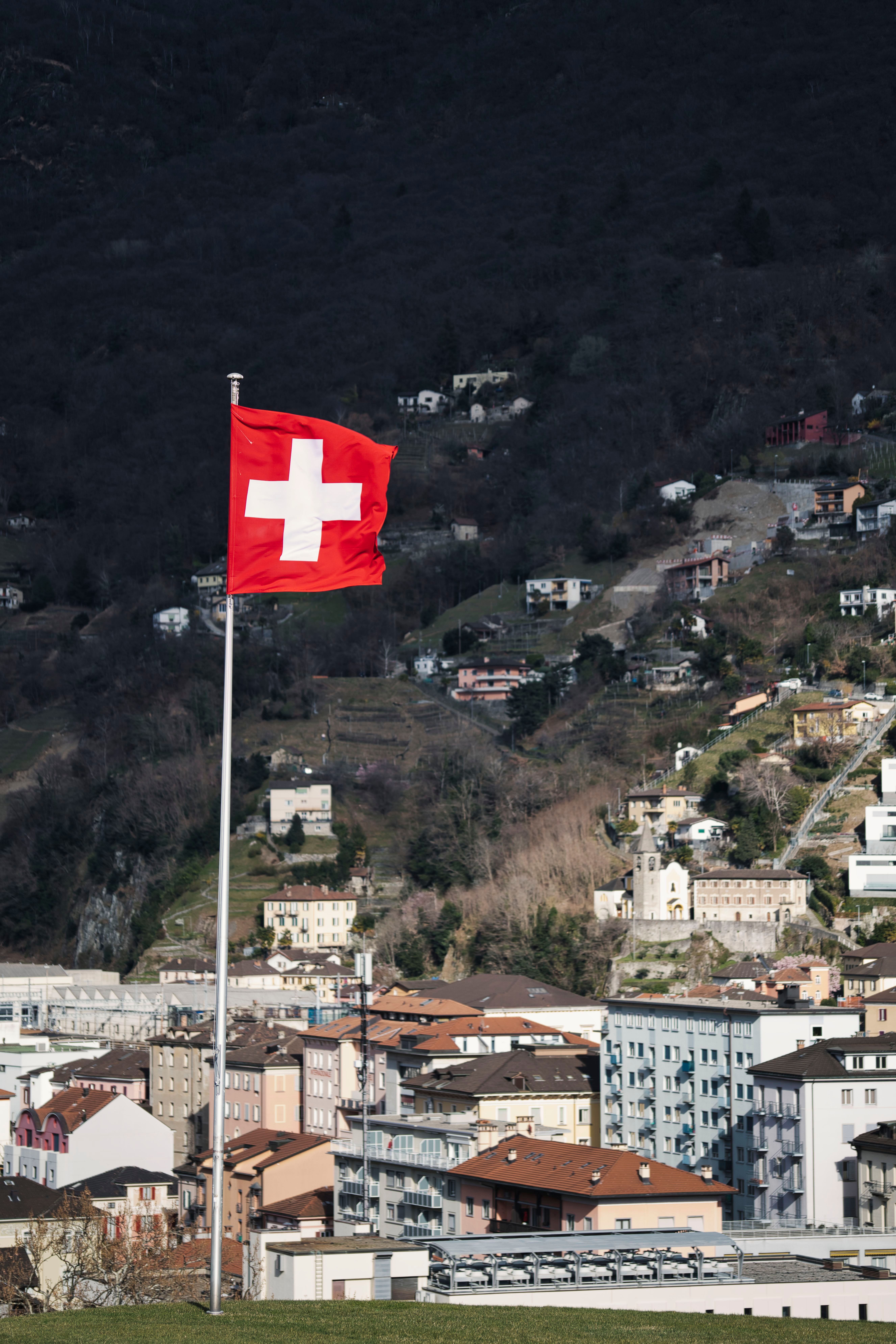 Flag of Switzerland over Town · Free Stock Photo