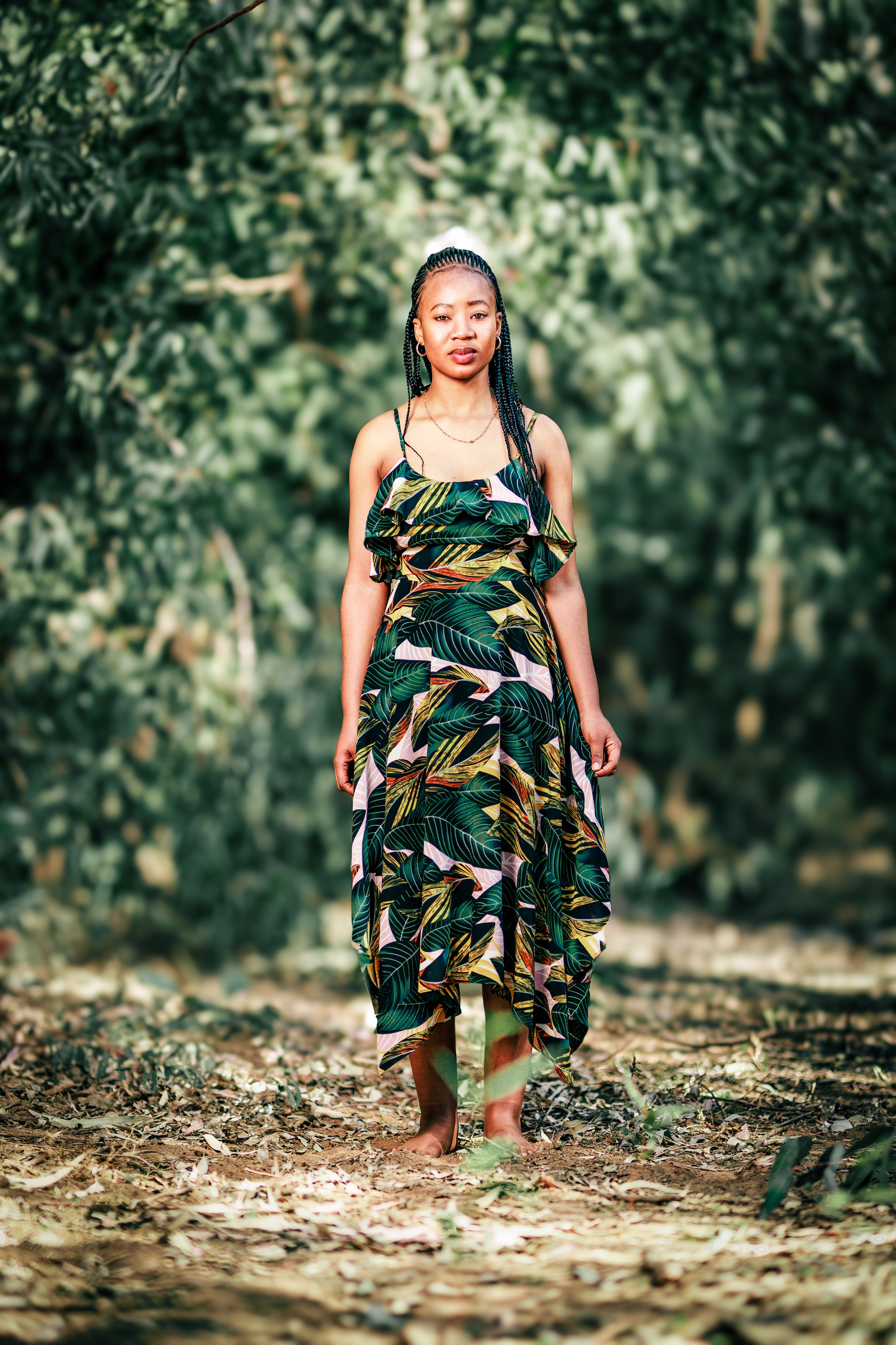 A Young Woman Wearing a Dress Posing in a Forest · Free Stock Photo