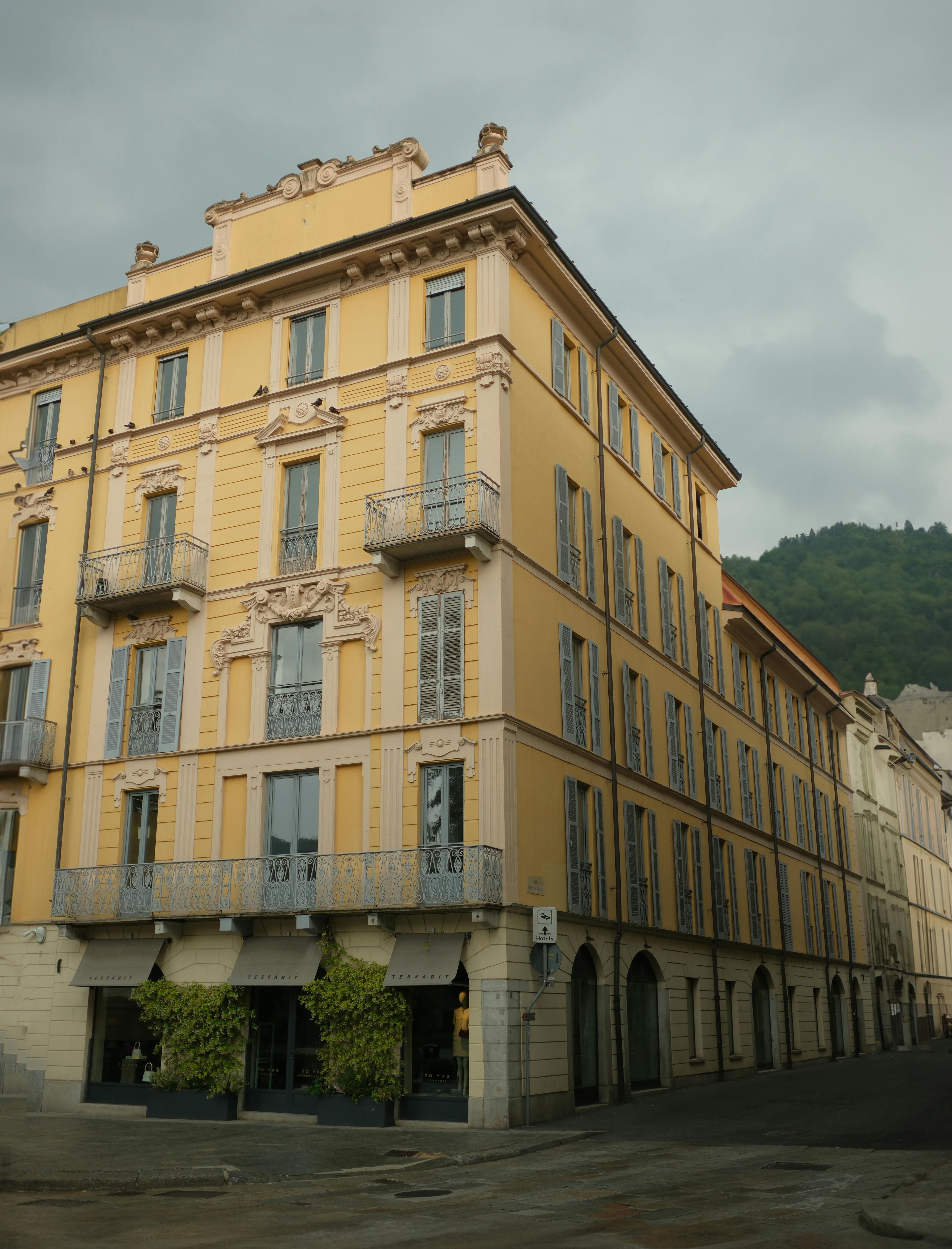 A yellow building with balconies on the side of the street · Free Stock ...