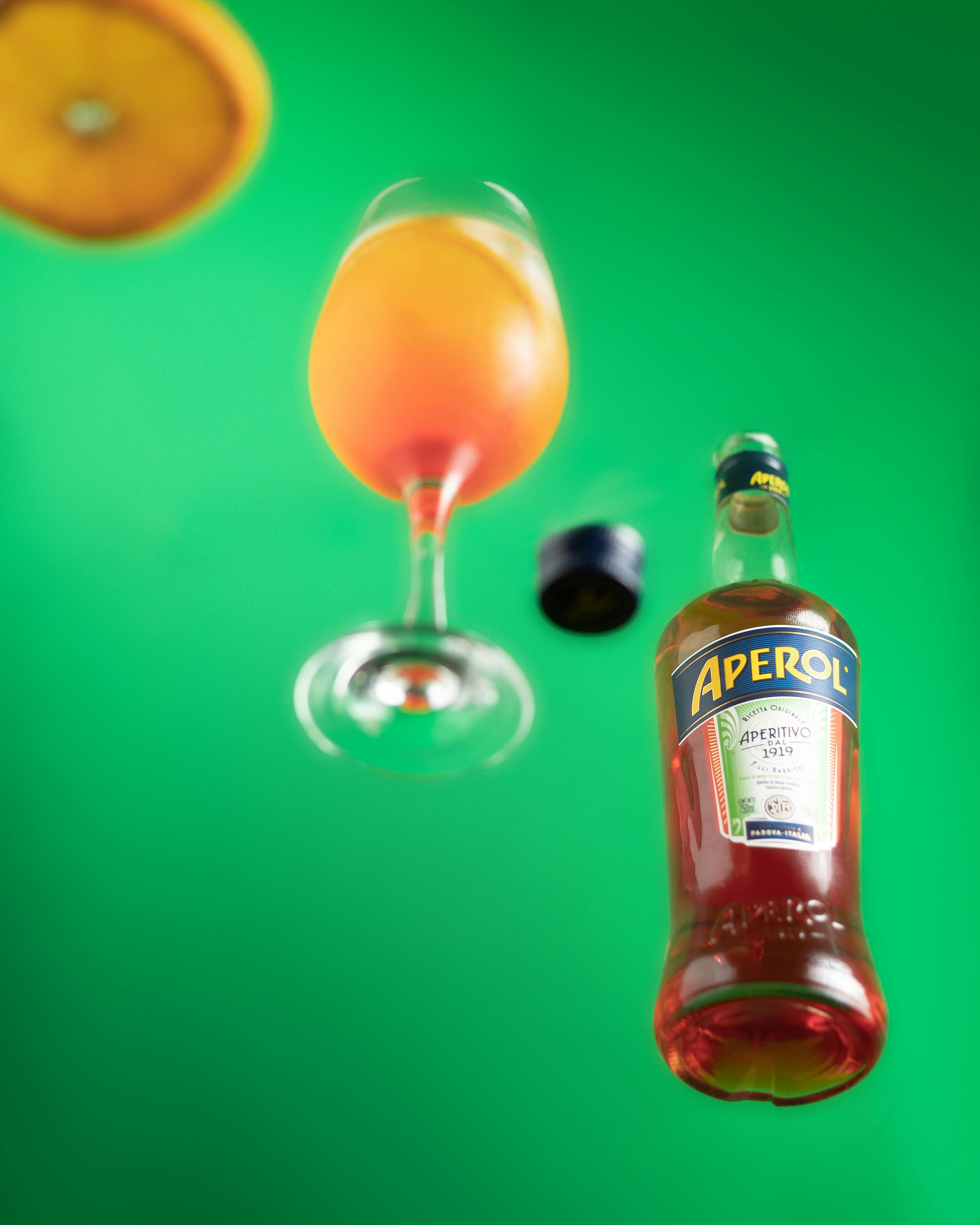 Dynamic Aperol Bottle with Cocktail and Orange Slice · Free Stock Photo