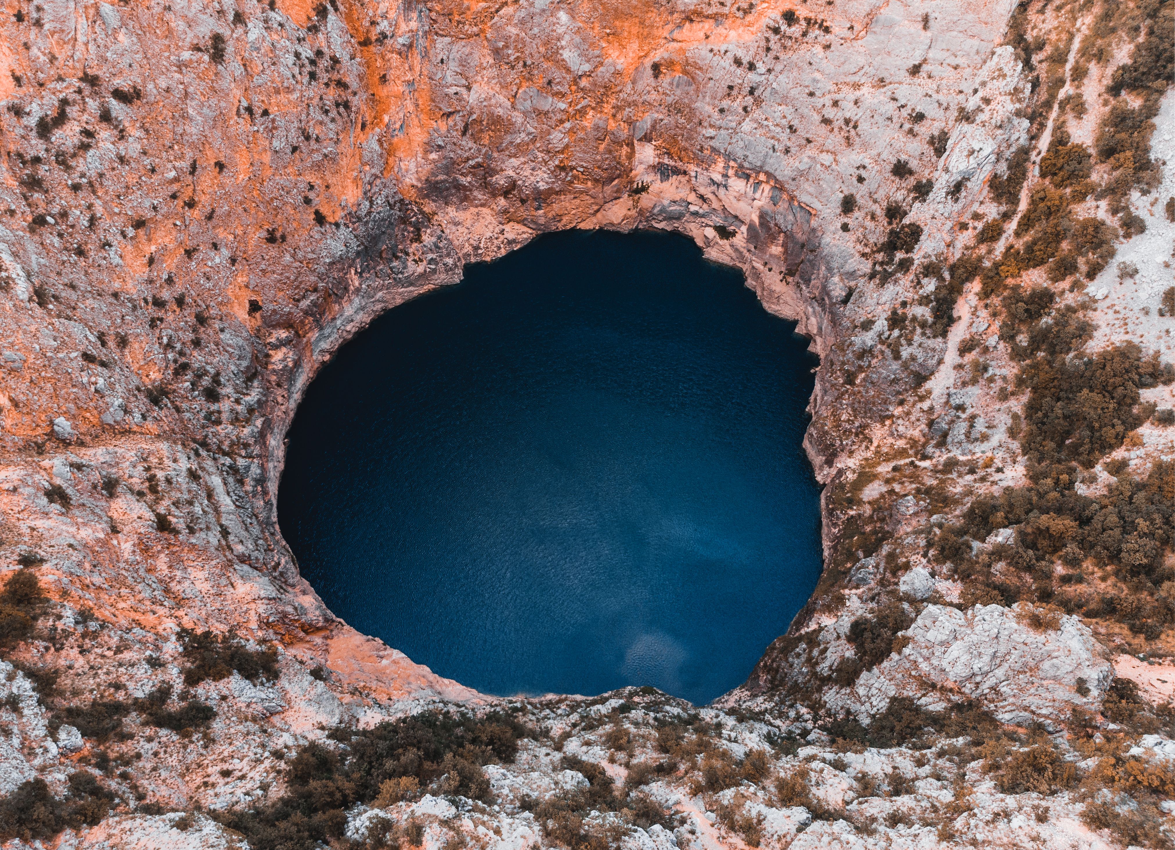 Close-up Photography of Hole and Body of Water · Free Stock Photo