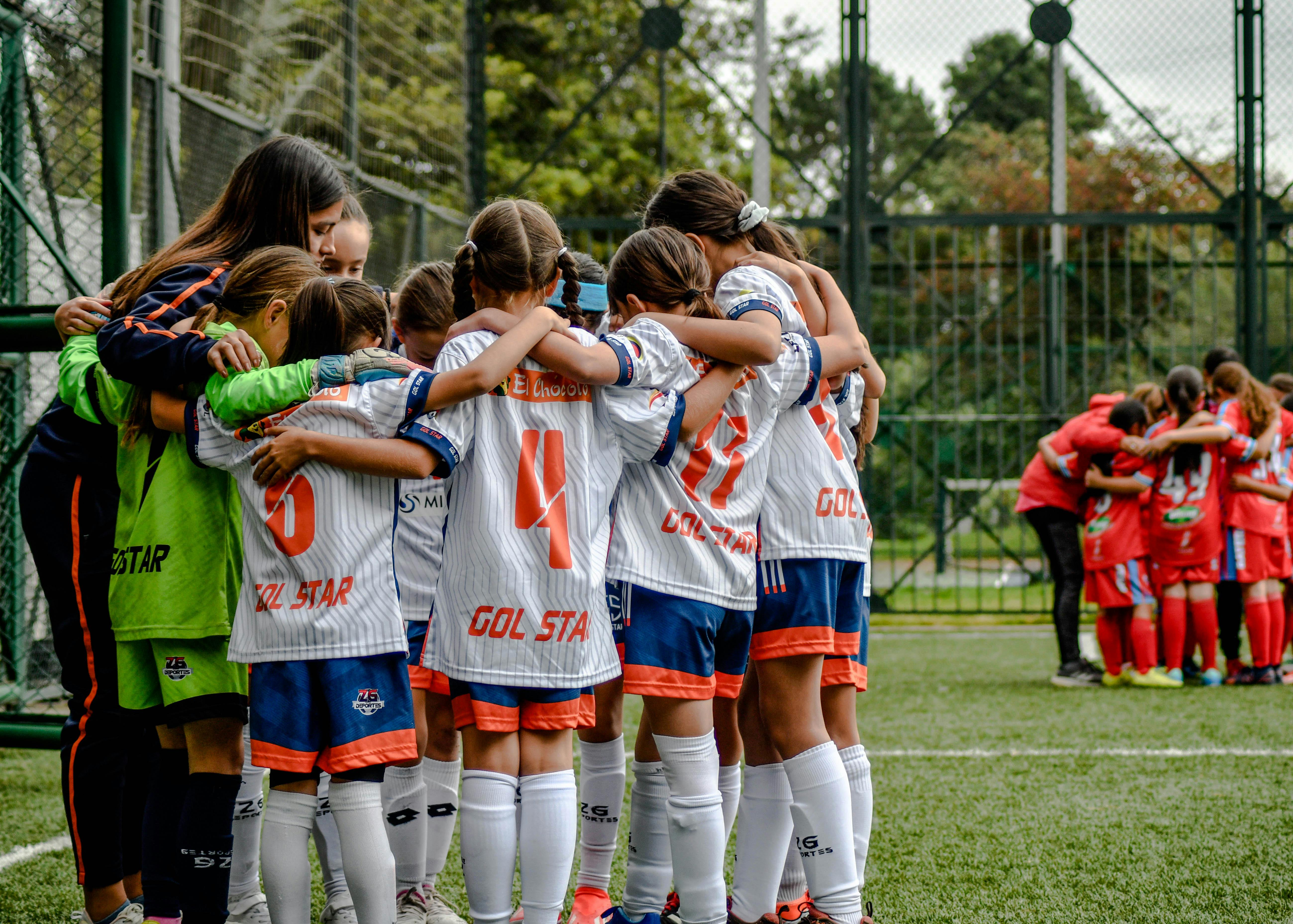 Youth Soccer Team Huddle on Sports Field · Free Stock Photo