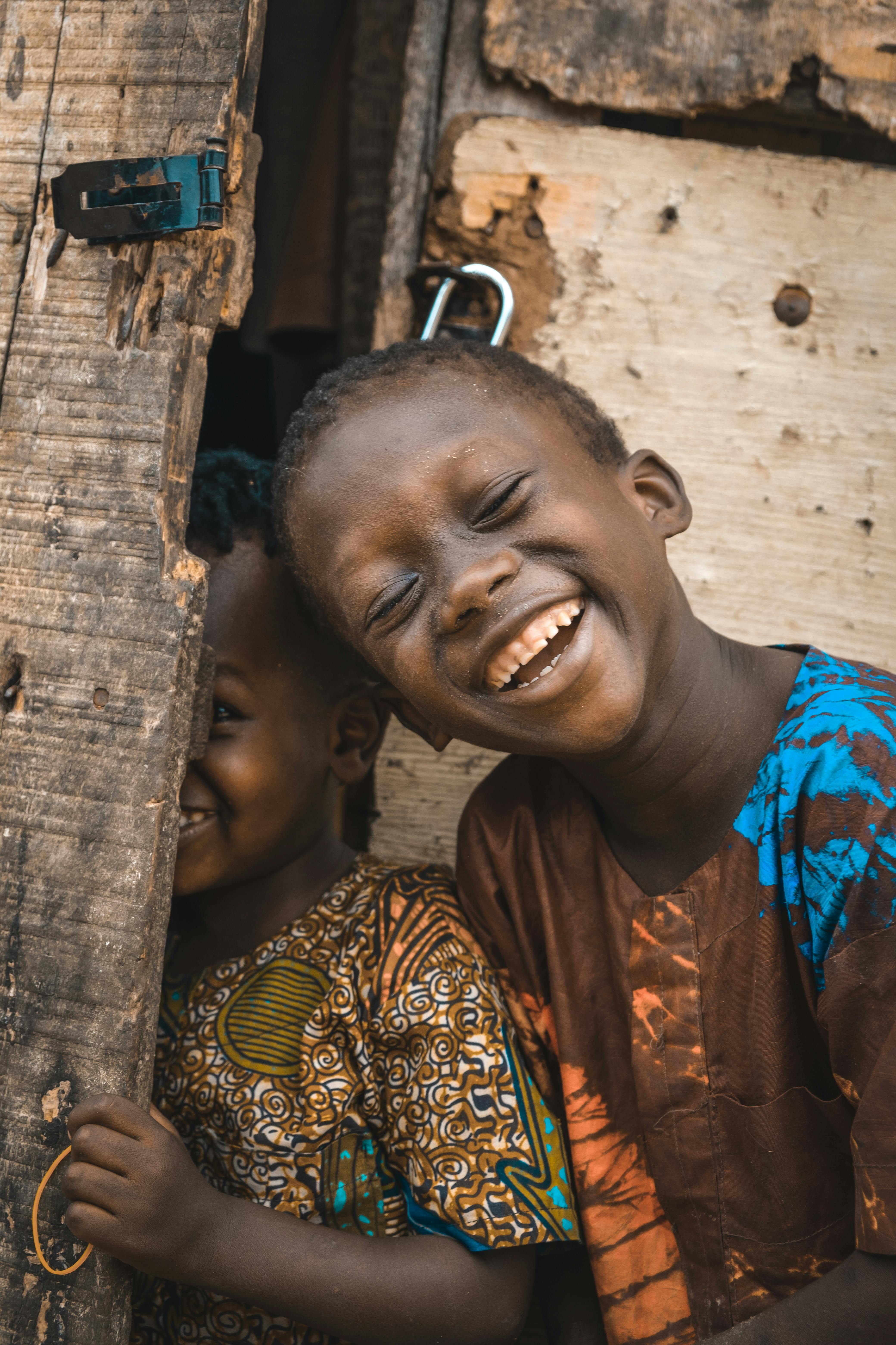 A group of African children smiling and holding food · Free Stock Photo