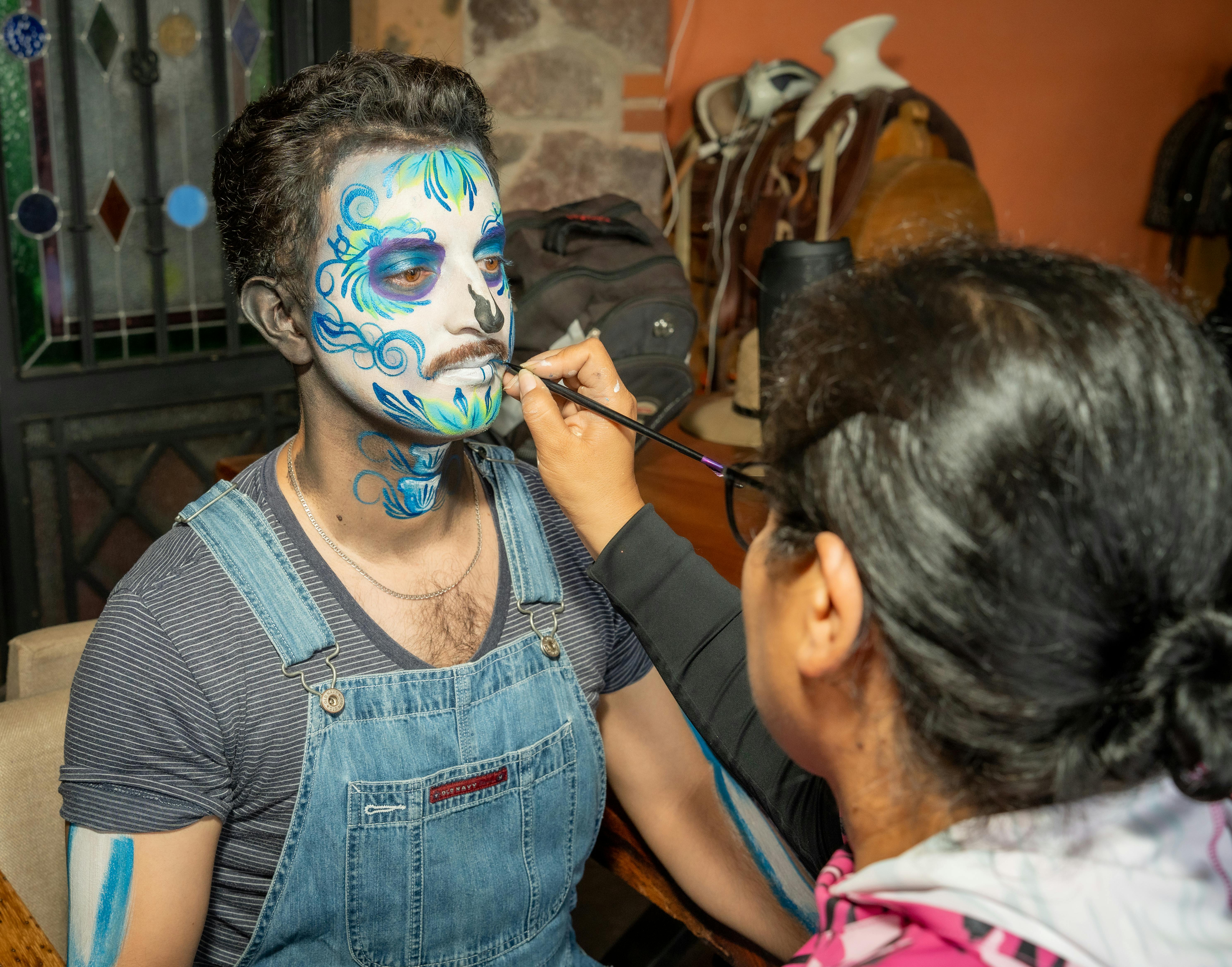 A woman with blue face paint and a man with blue face paint · Free ...