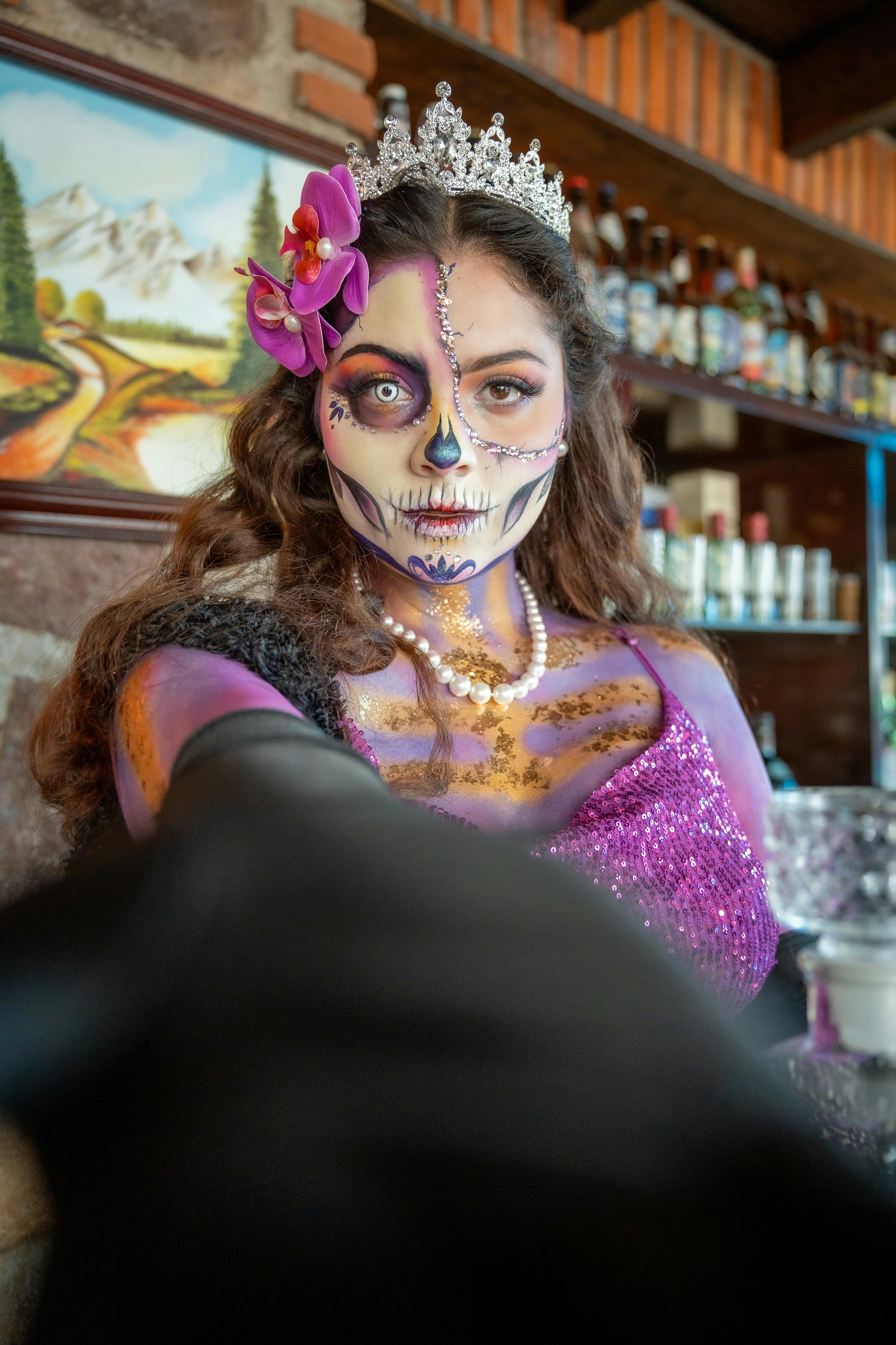 A woman in a skeleton costume at a bar · Free Stock Photo