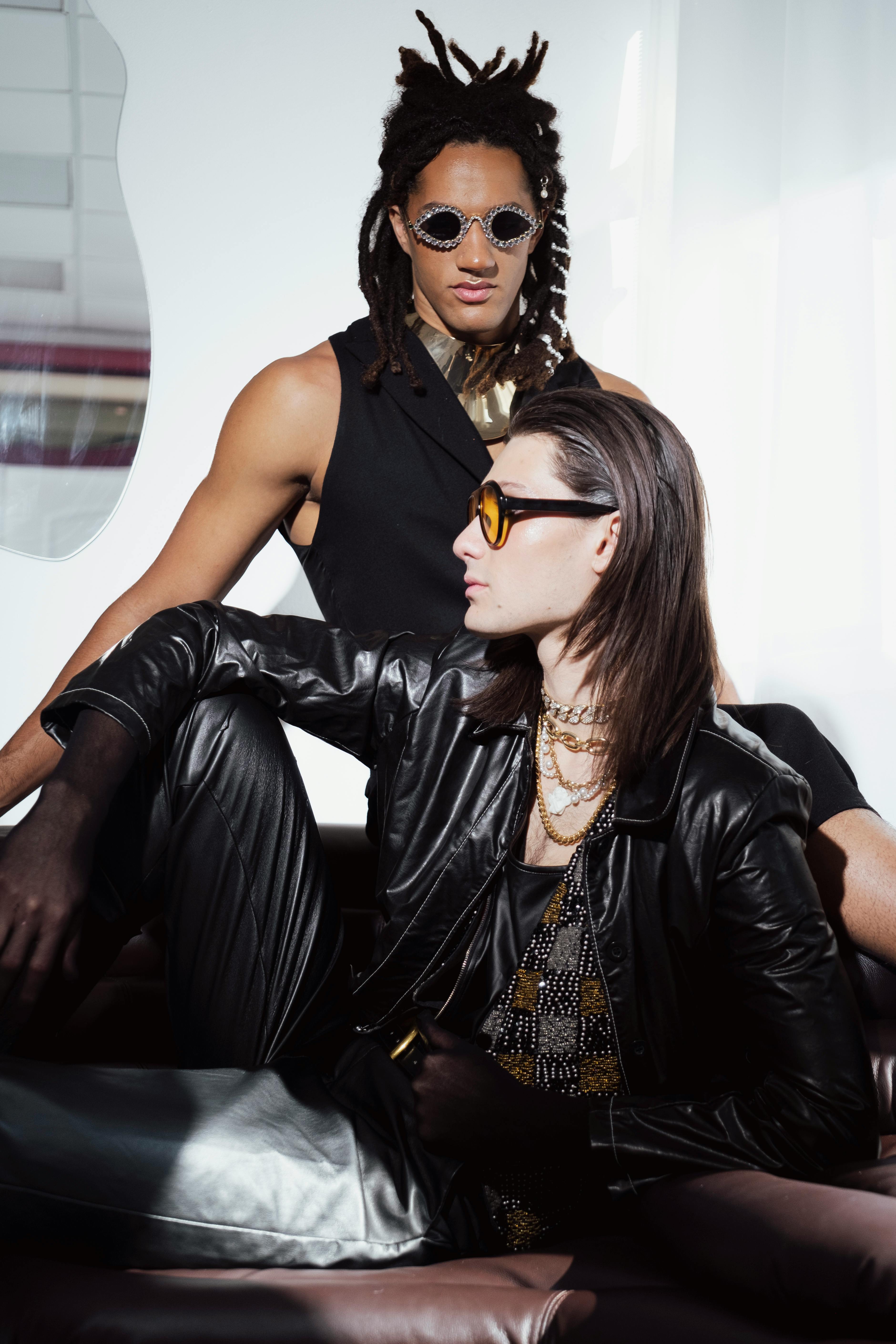 Two people in leather jackets sitting on a couch · Free Stock Photo