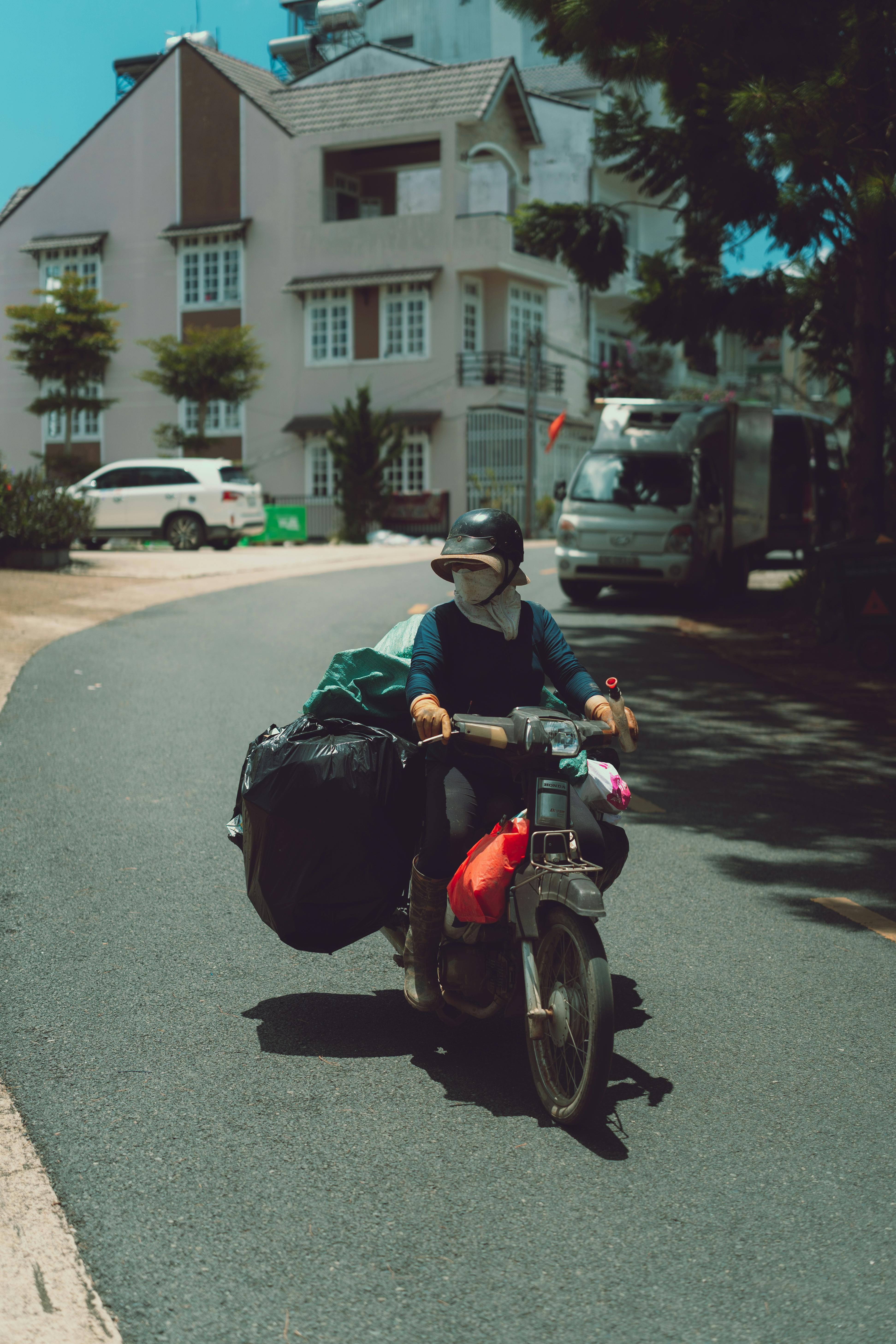 Person Riding on a Bike on the Road in a City · Free Stock Photo