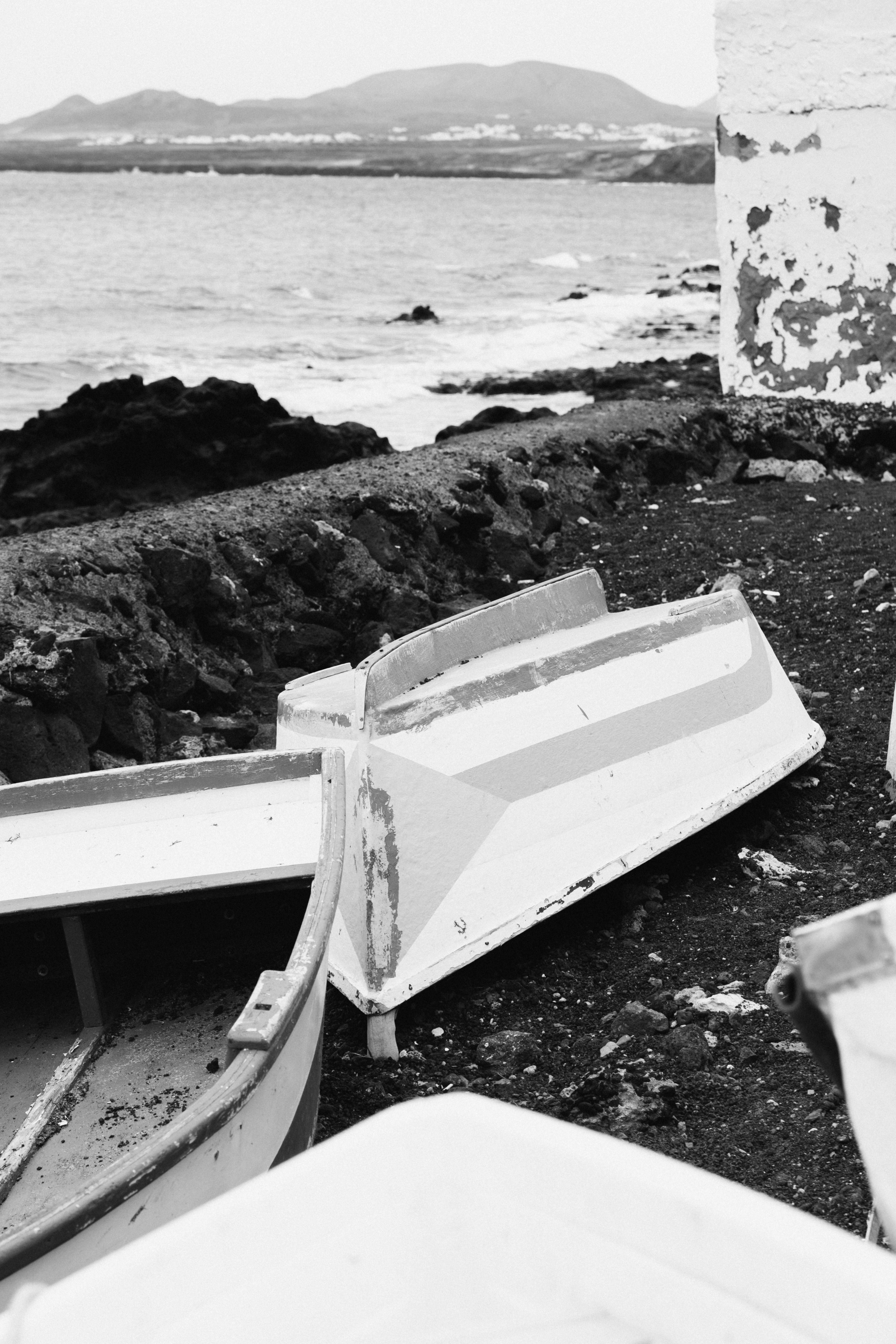 Black and white photograph of boats on the beach · Free Stock Photo