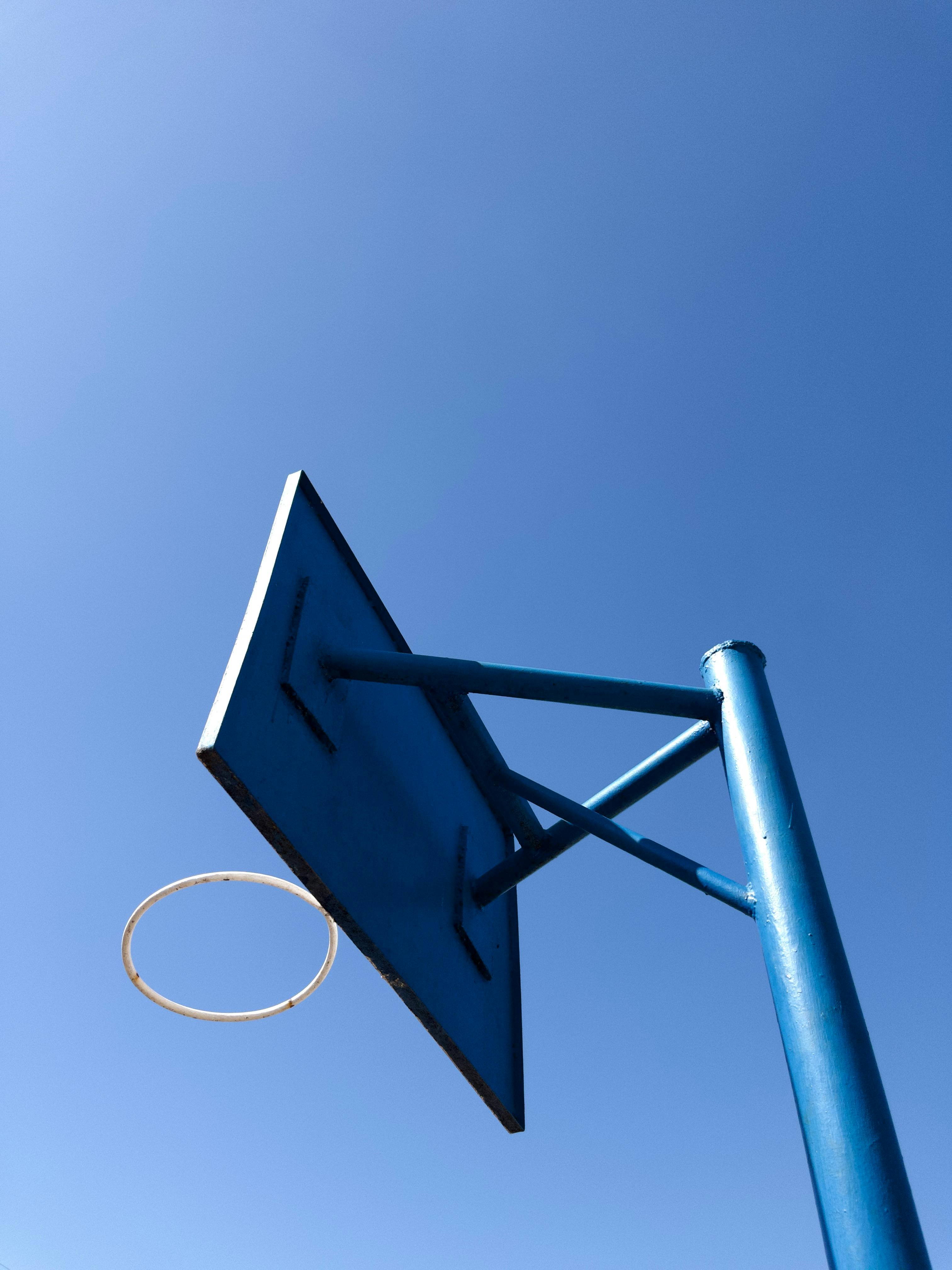 Blue Basketball Hoop Against the Blue Sky · Free Stock Photo