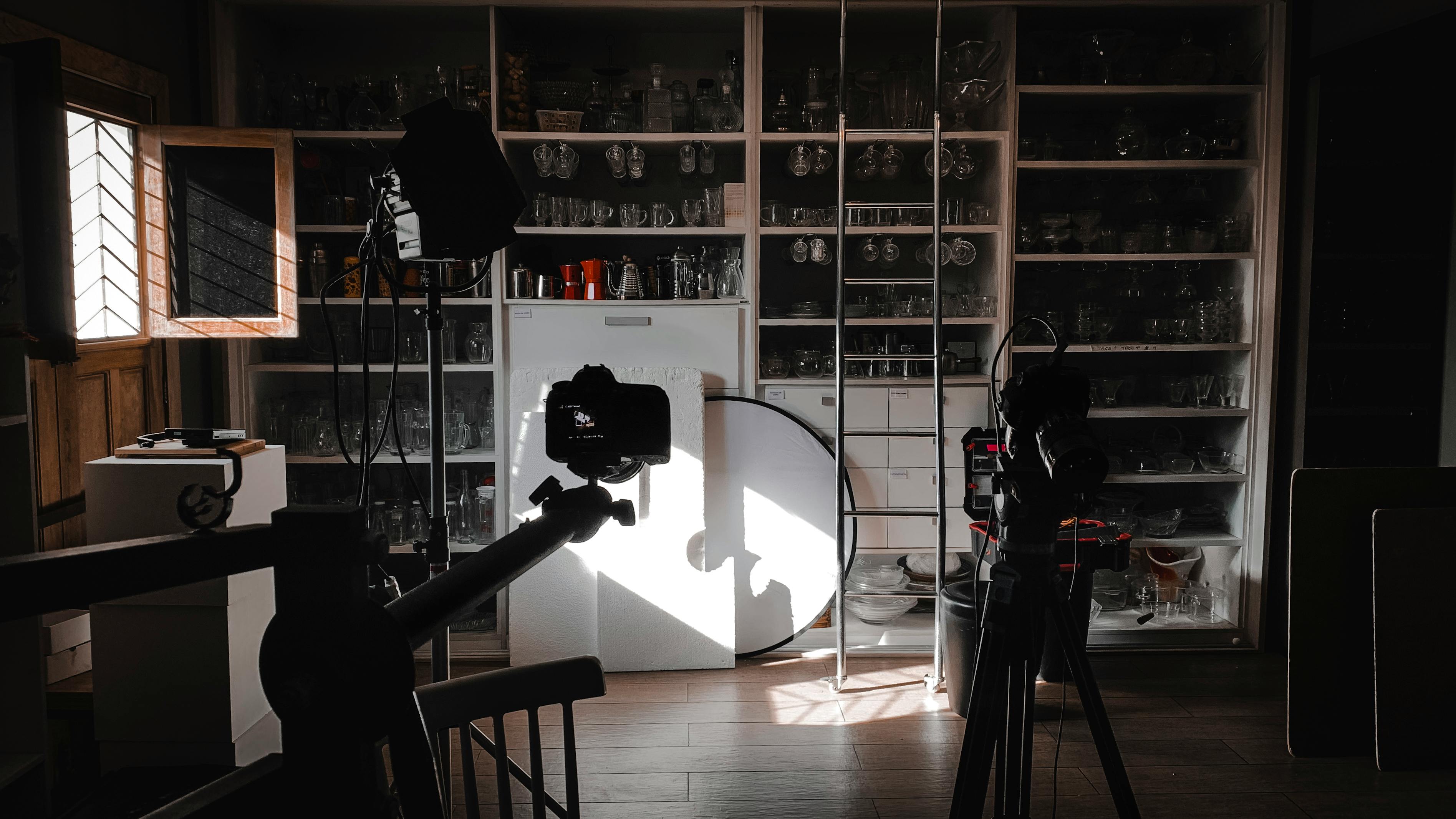 Cupboard with Glasses, and Cameras in the Studio · Free Stock Photo