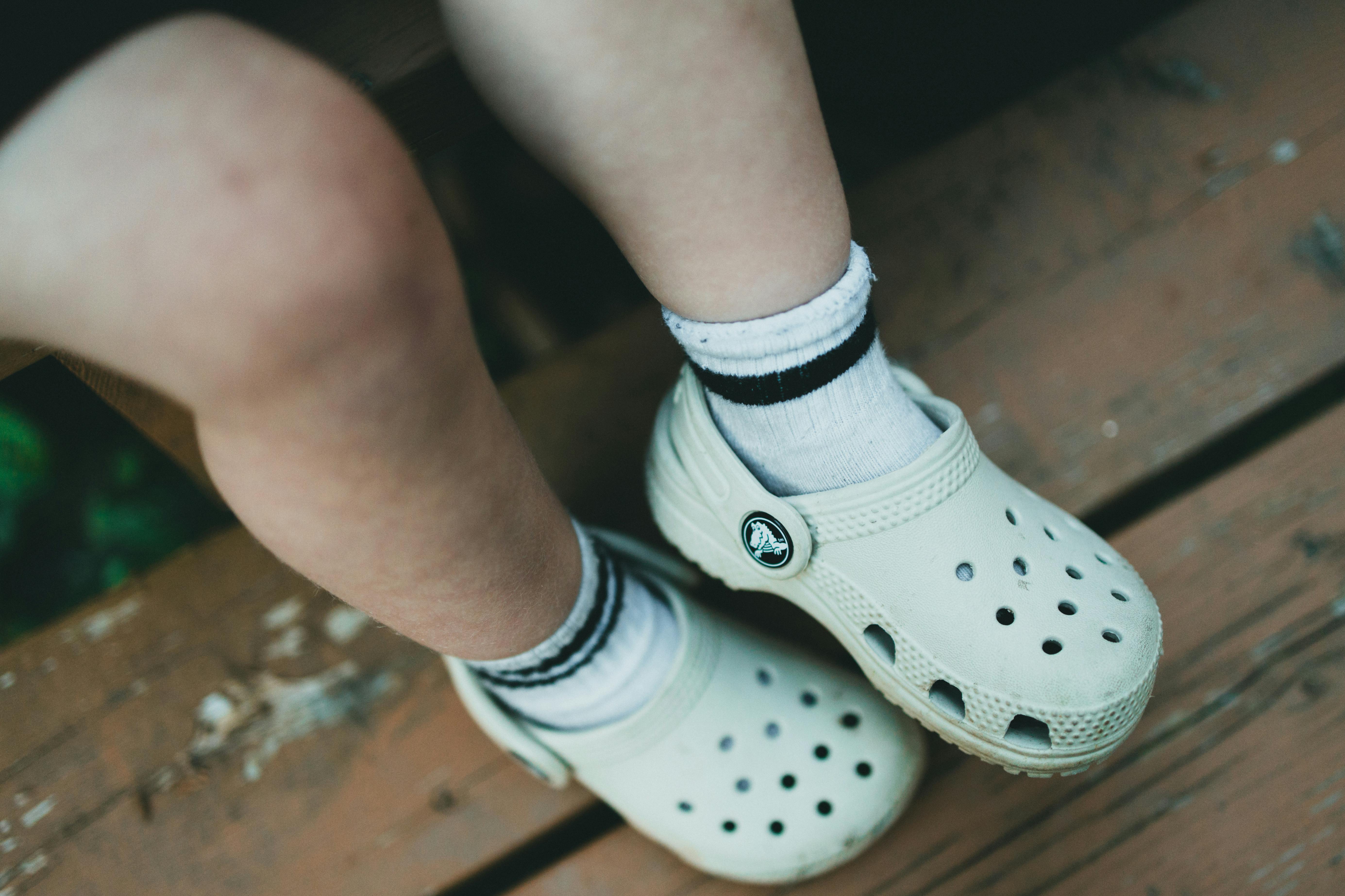 Crocs Footwear on Person Legs · Free Stock Photo