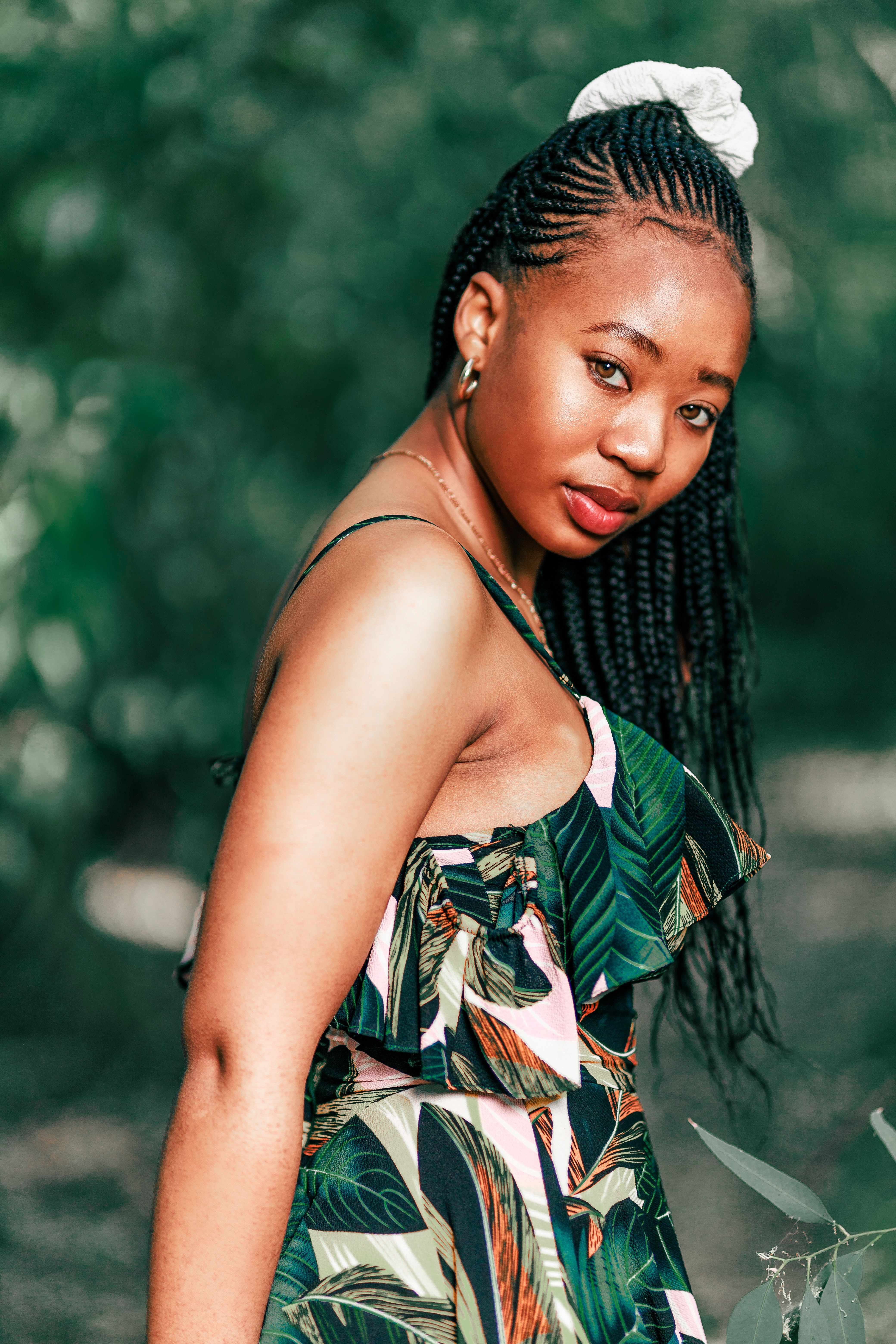 A woman with braids in a tropical print dress · Free Stock Photo