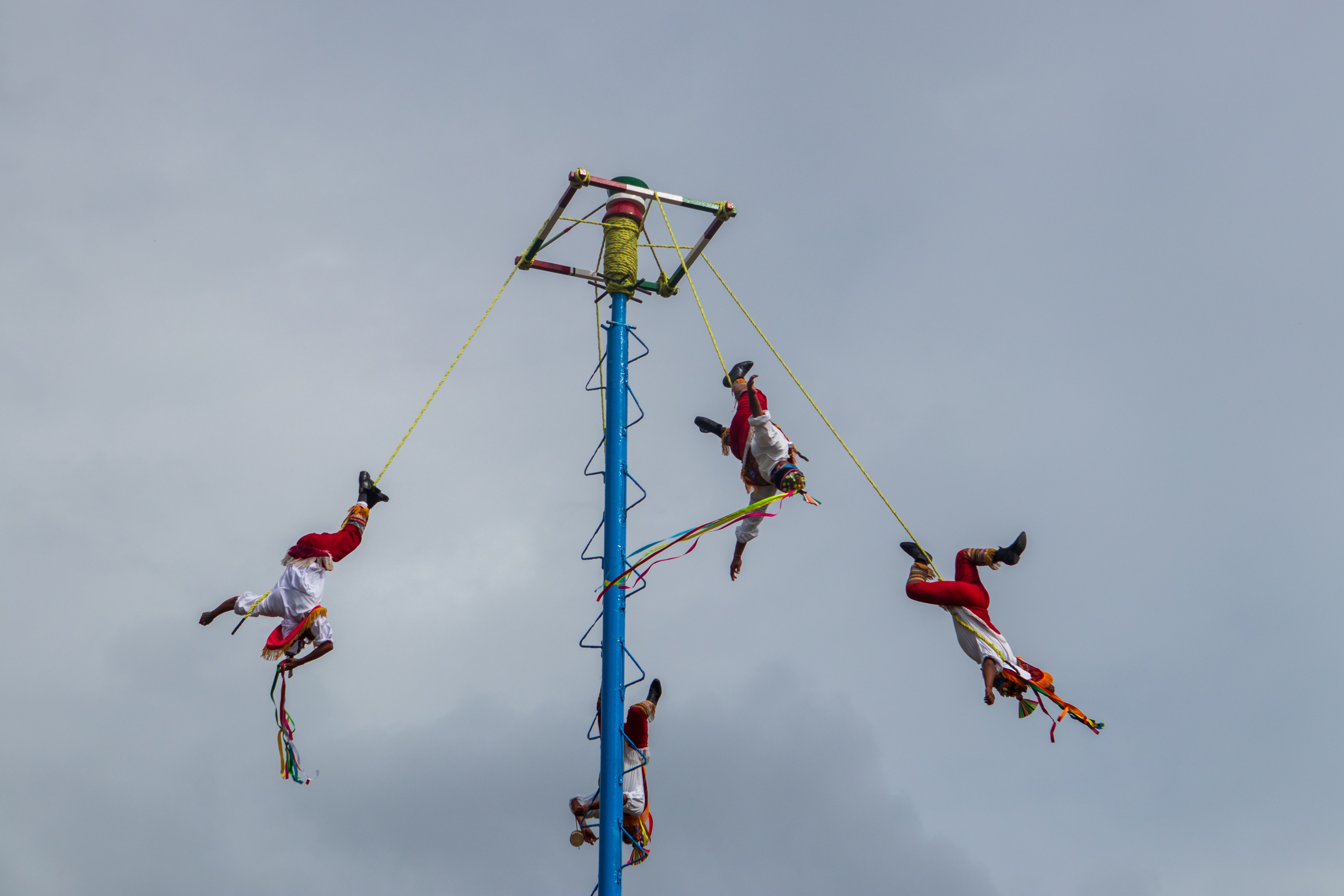 People Hanging and Dancing on Ropes on Pole · Free Stock Photo