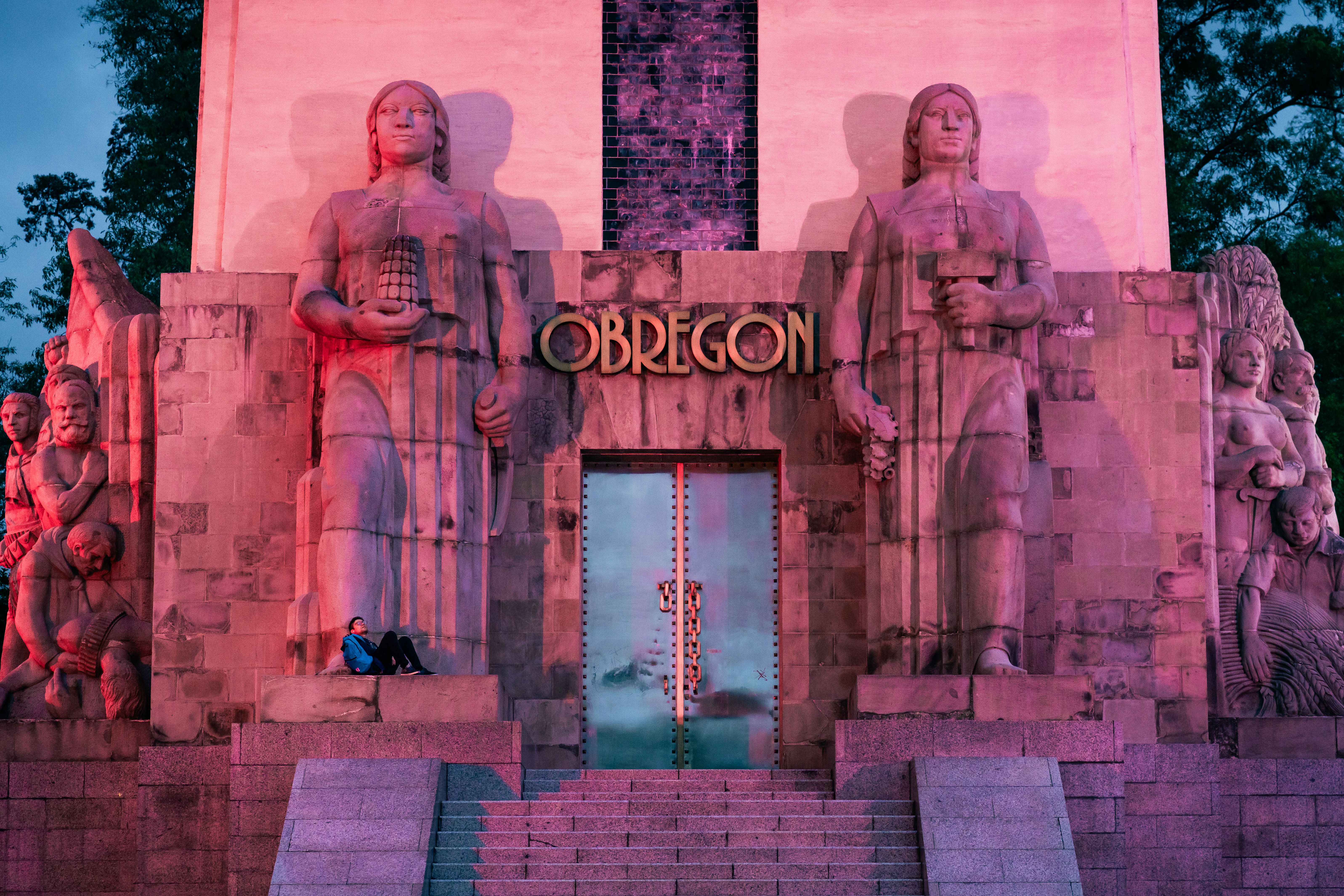 The entrance to a building with statues on it · Free Stock Photo