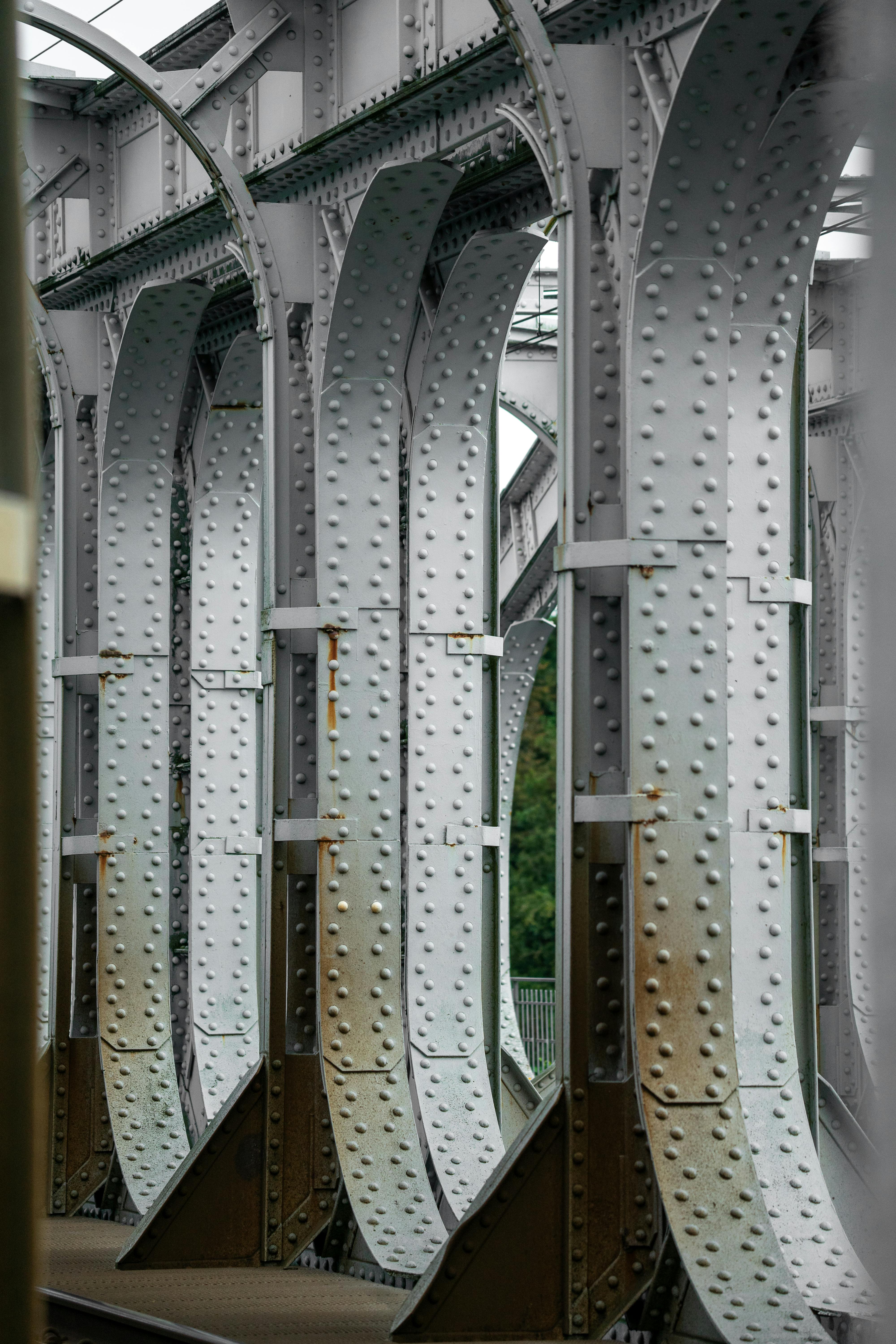 A close up of a metal bridge with many holes · Free Stock Photo