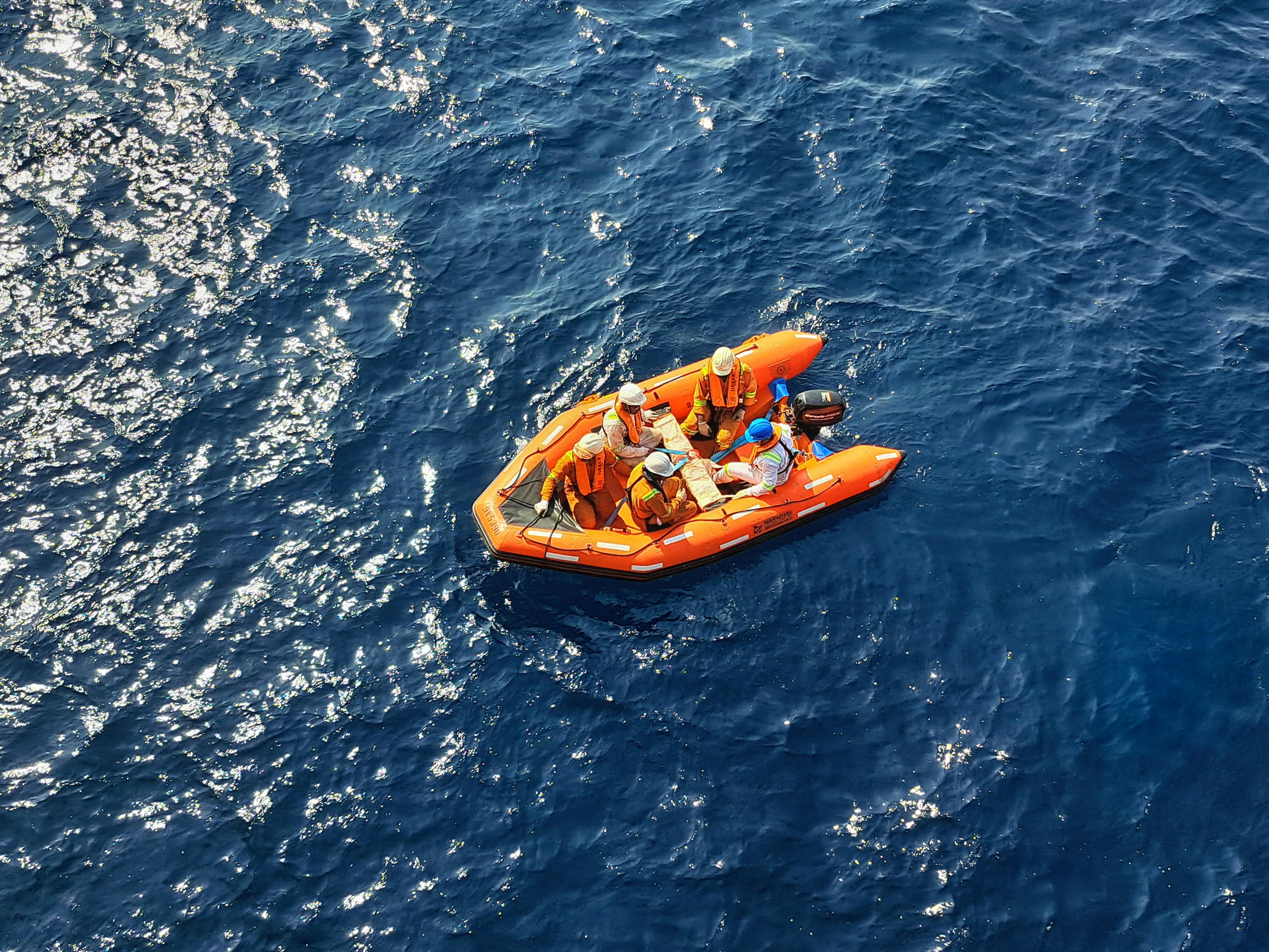 Men on a Lifeboat in the Middle of a Sea · Free Stock Photo