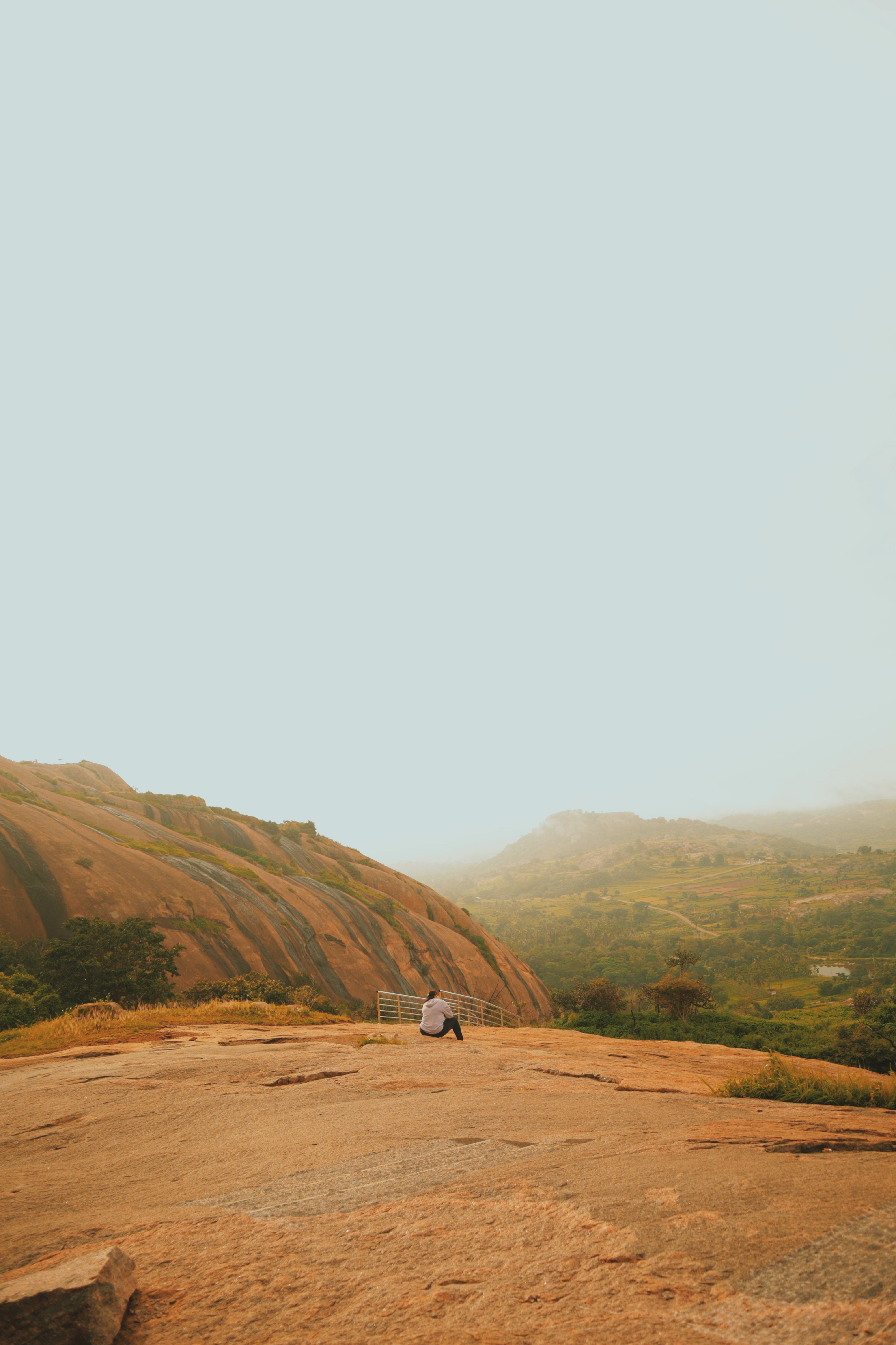 Person Sitting on Sand on Chithannavasal Cave Temple Hill in India ...