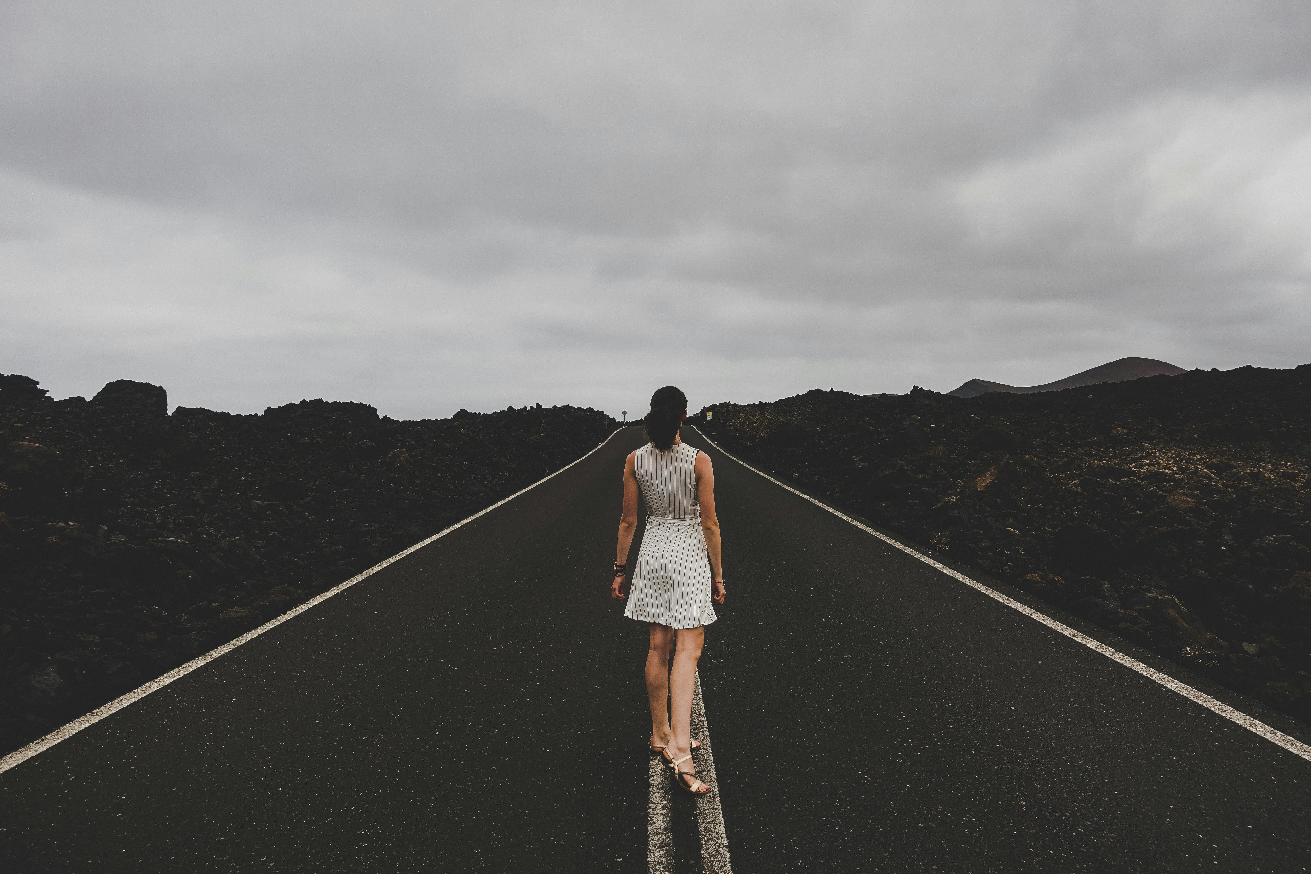 Woman Standing on Concrete Road · Free Stock Photo