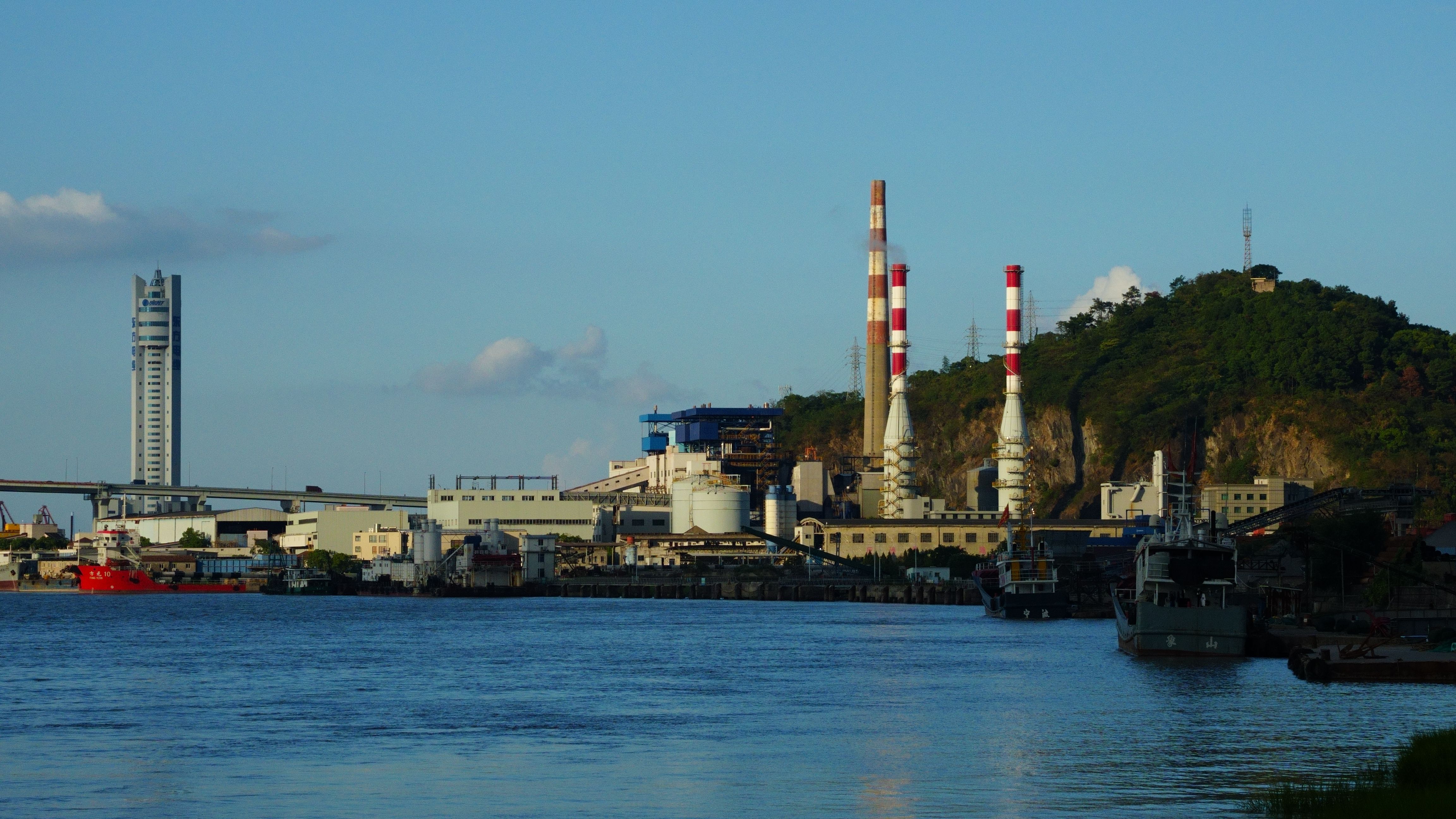 Industrial Waterfront with Smokestacks and Buildings · Free Stock Photo