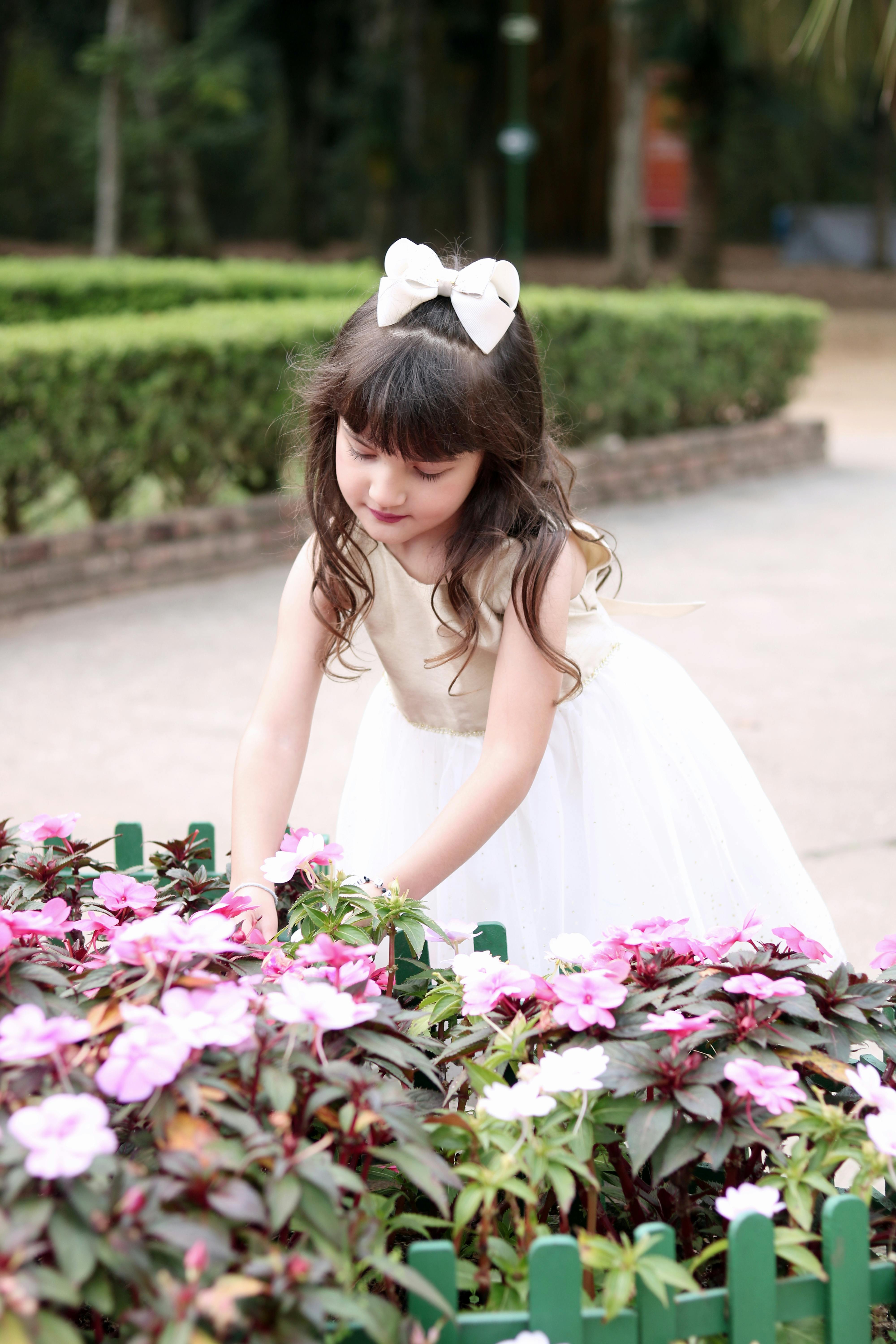 Girl Touching Bush · Free Stock Photo