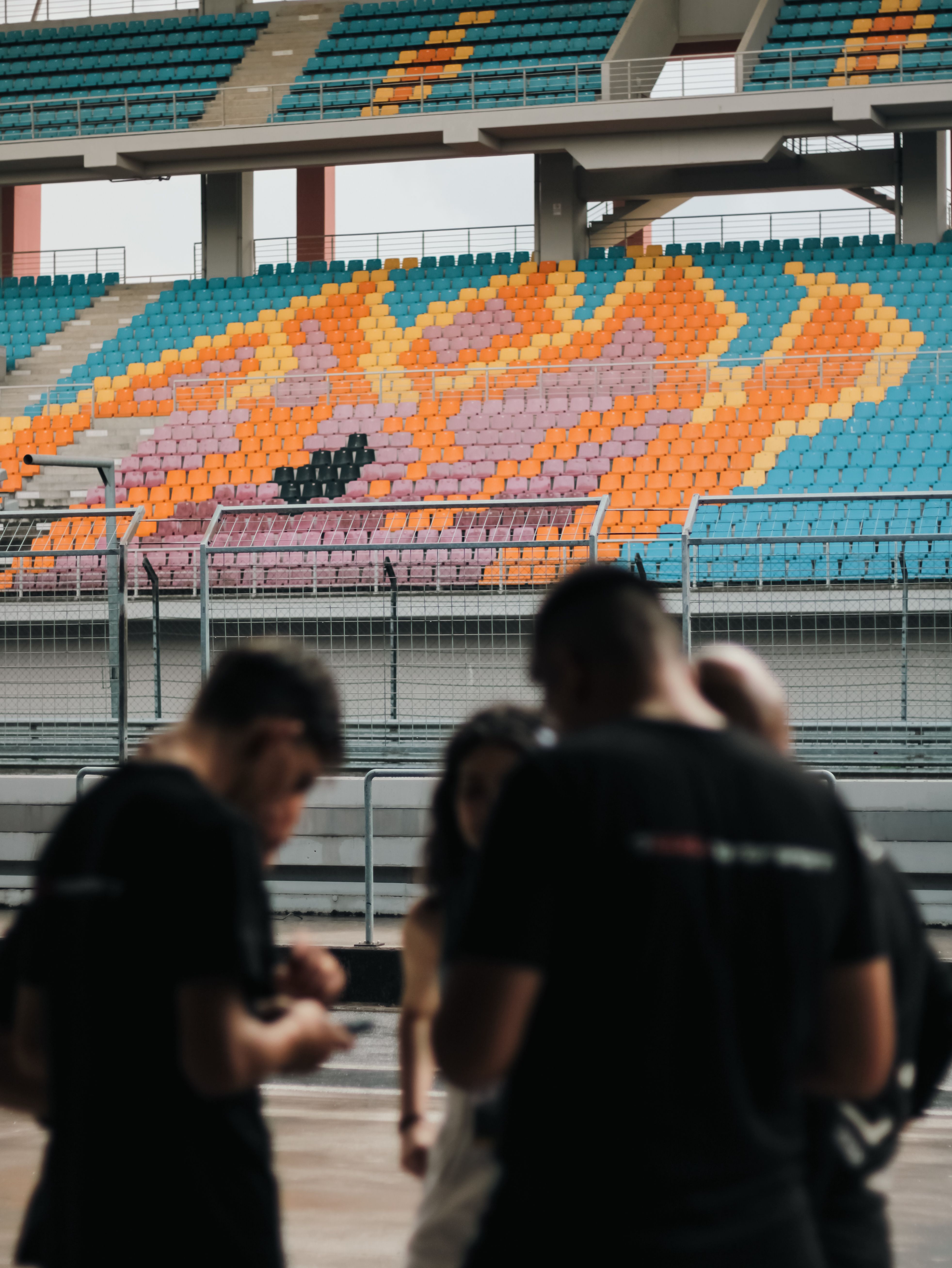 A group of people standing in front of a stadium · Free Stock Photo